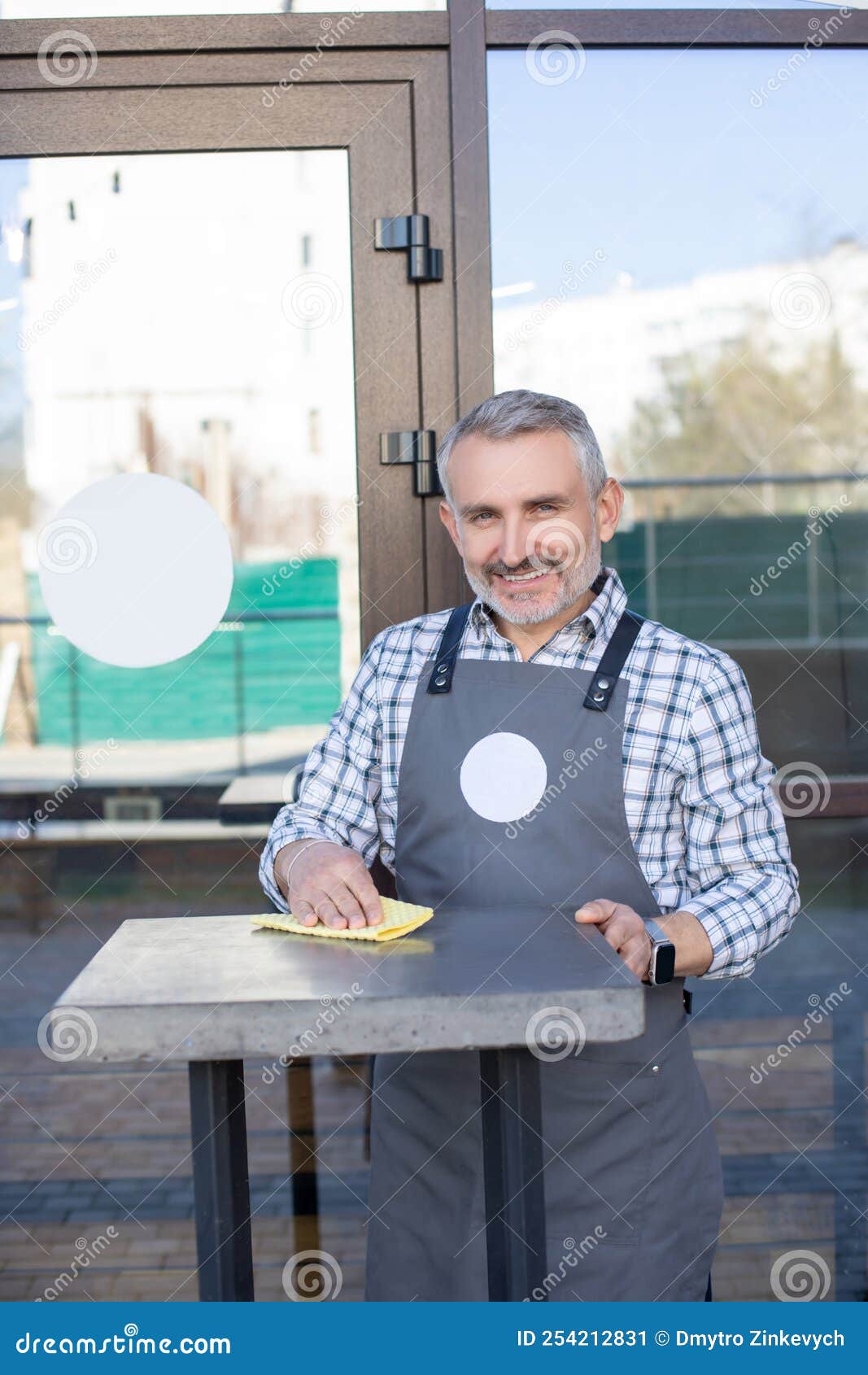 Man in Apron Cleaning the Tables in a Street Cafe Stock Image - Image ...