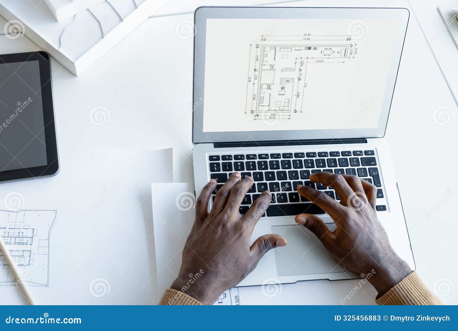 Man Architect Working with Software on Laptop Using Technical Drafts ...