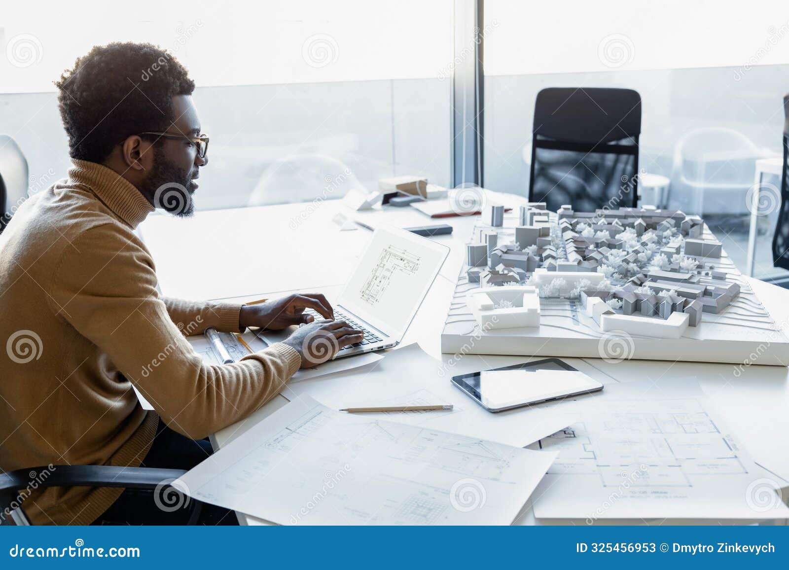 Man Architect Working with Software on Laptop Using Technical Drafts ...