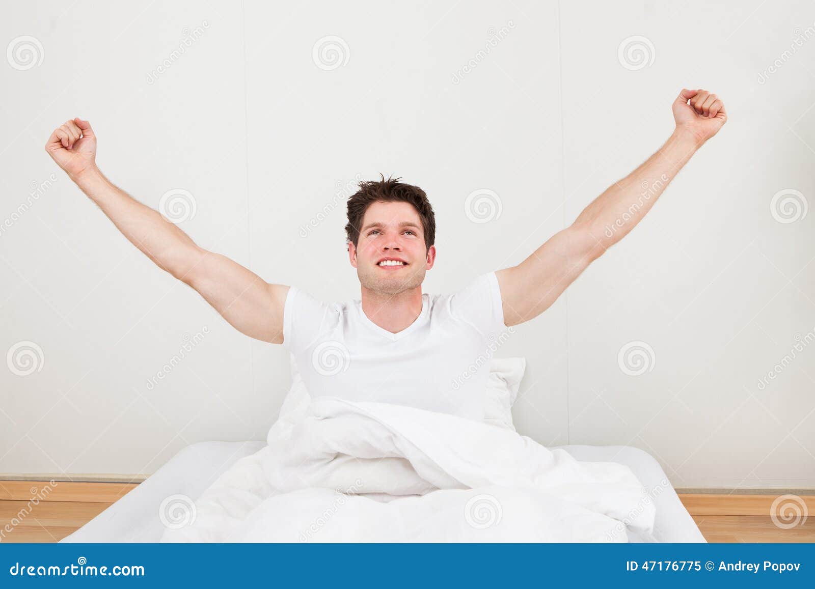Man with arm raised on bed stock image. Image of relaxation - 47176775