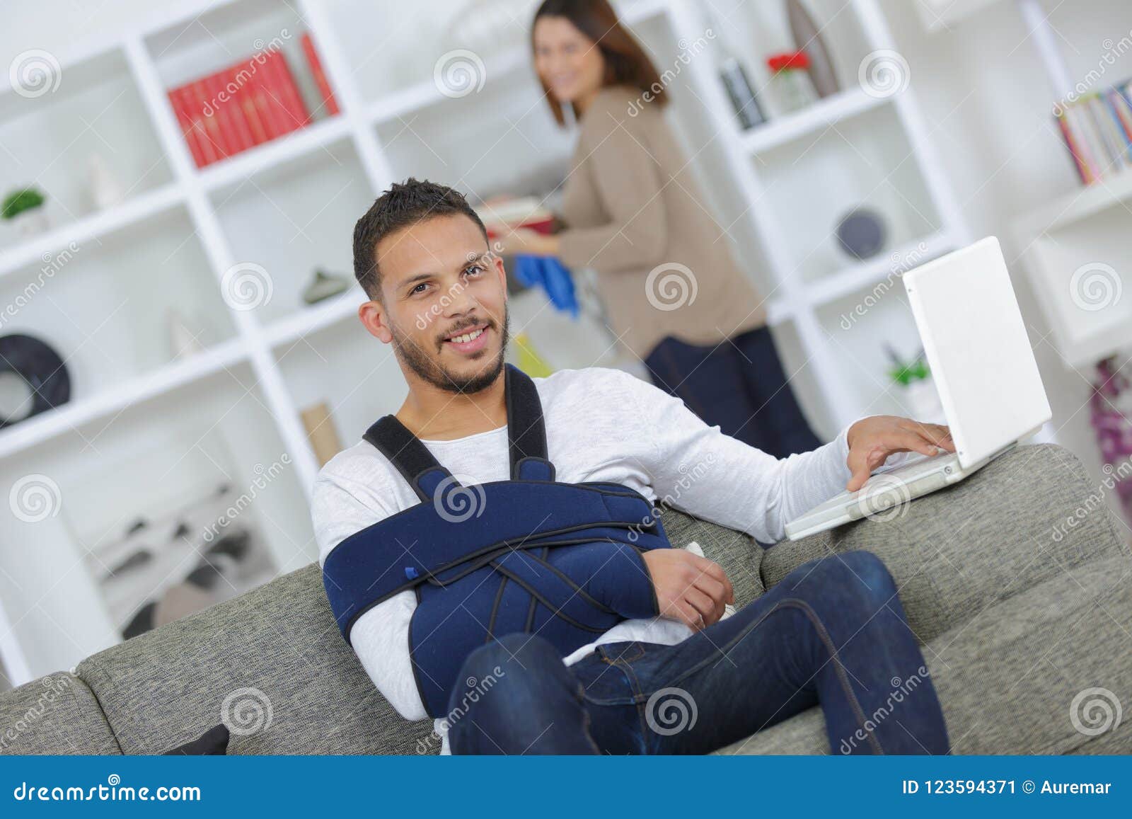 Man with Arm in Sling Using Computer Left Handed Stock Image - Image of ...