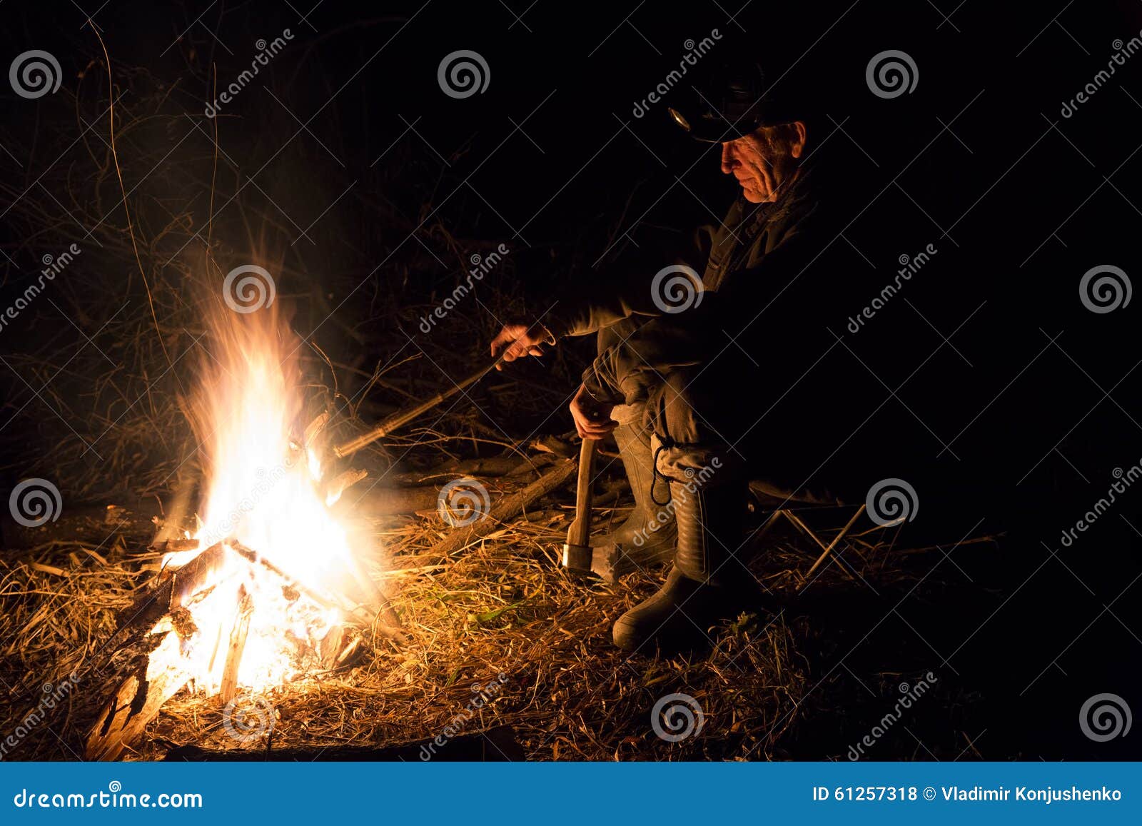 Man around the campfire stock photo. Image of night, heat - 61257318