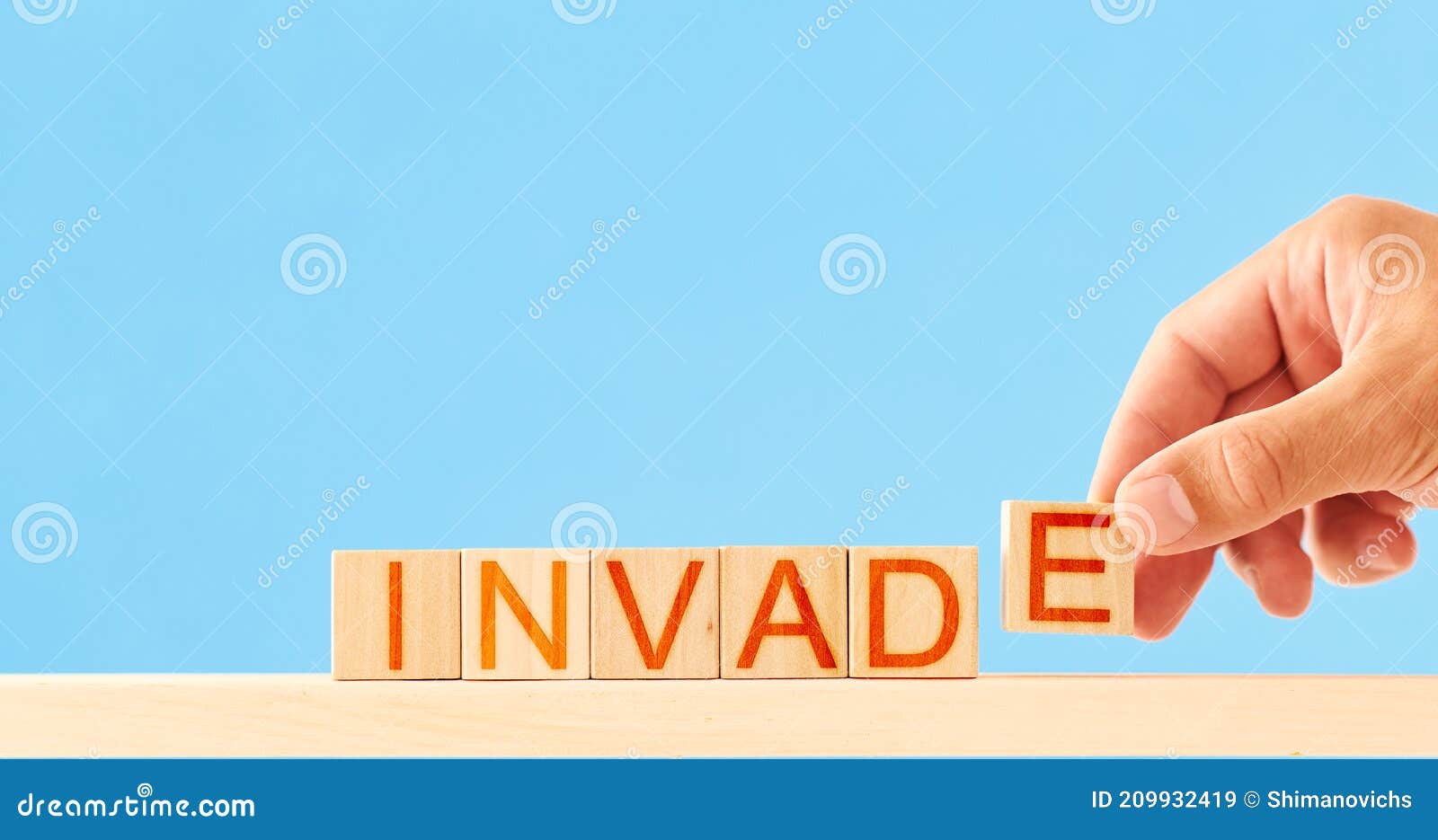 Man Arranges Wooden Blocks in Invade Inscription. Stock Image - Image ...