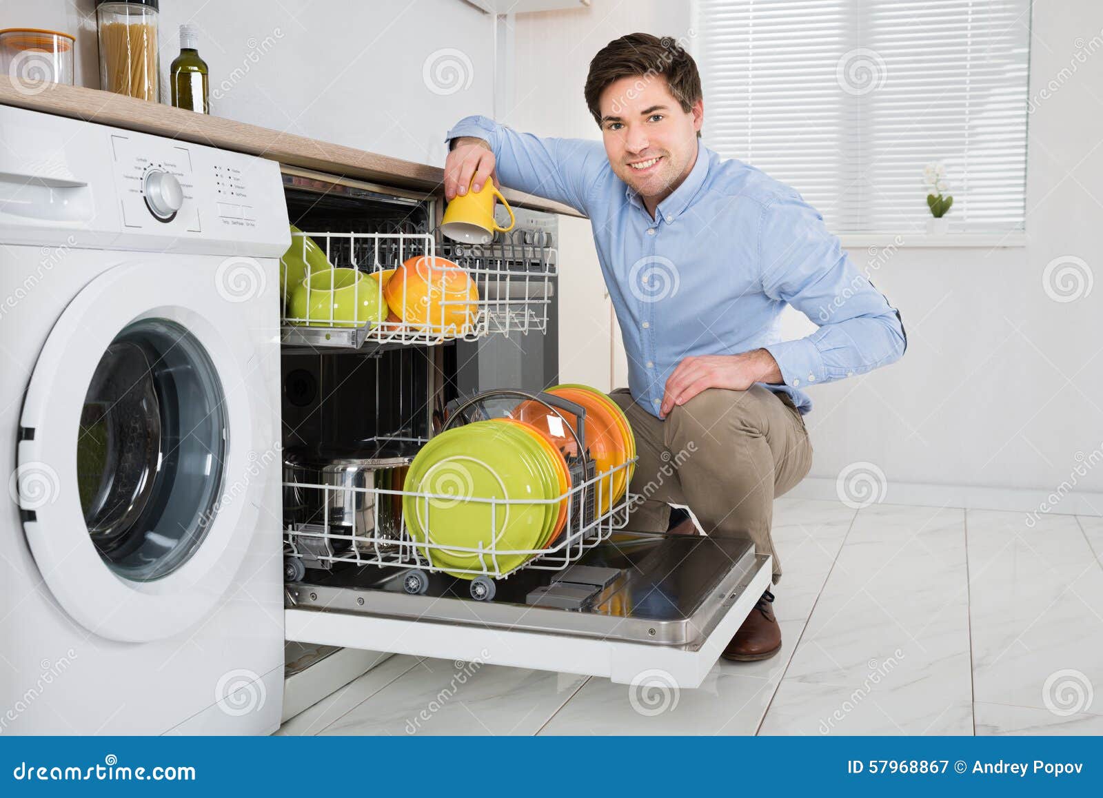 Man Arranging Dishes in Dishwasher Stock Image - Image of adult ...