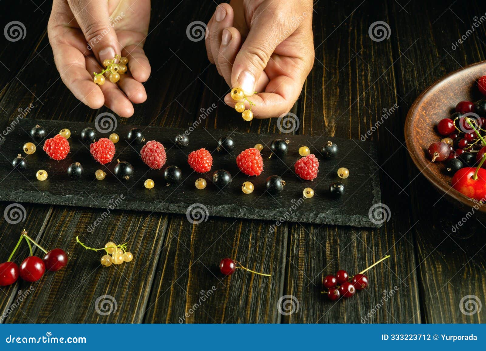 A Man Arranging Ripe Berries on a Sorting Board before Serving Them for ...