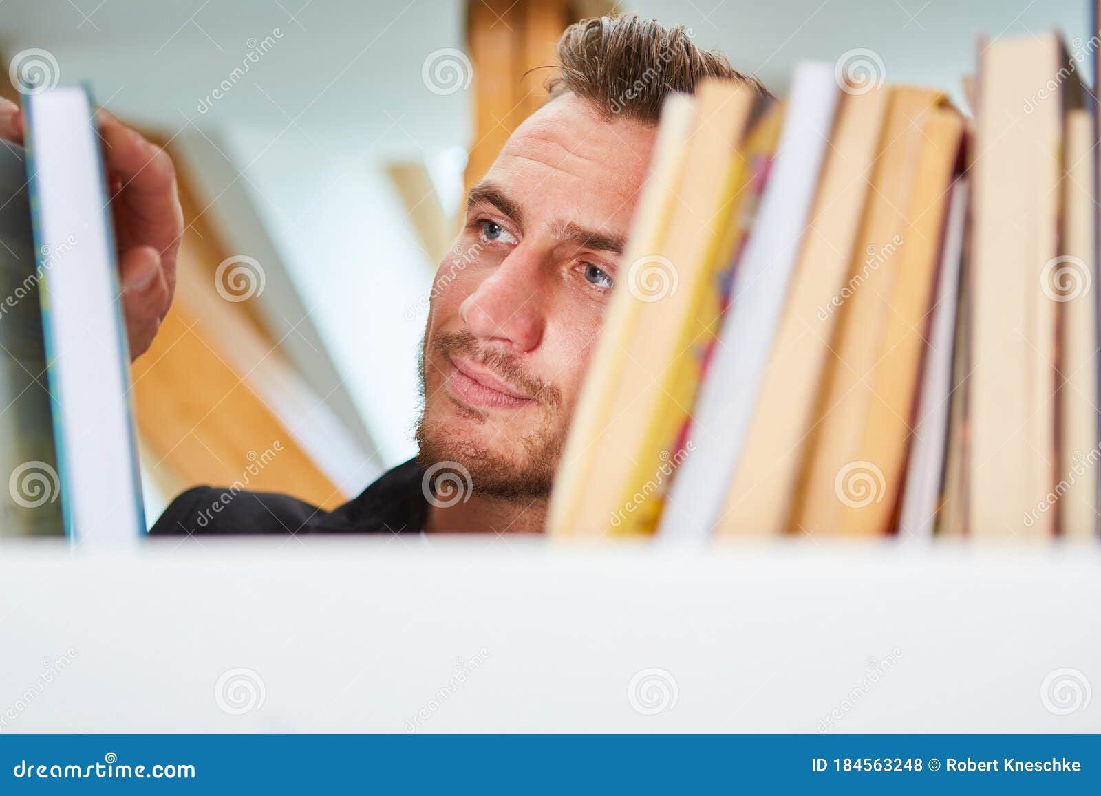 Man As a Librarian is Looking for a Book Stock Photo - Image of shelf ...