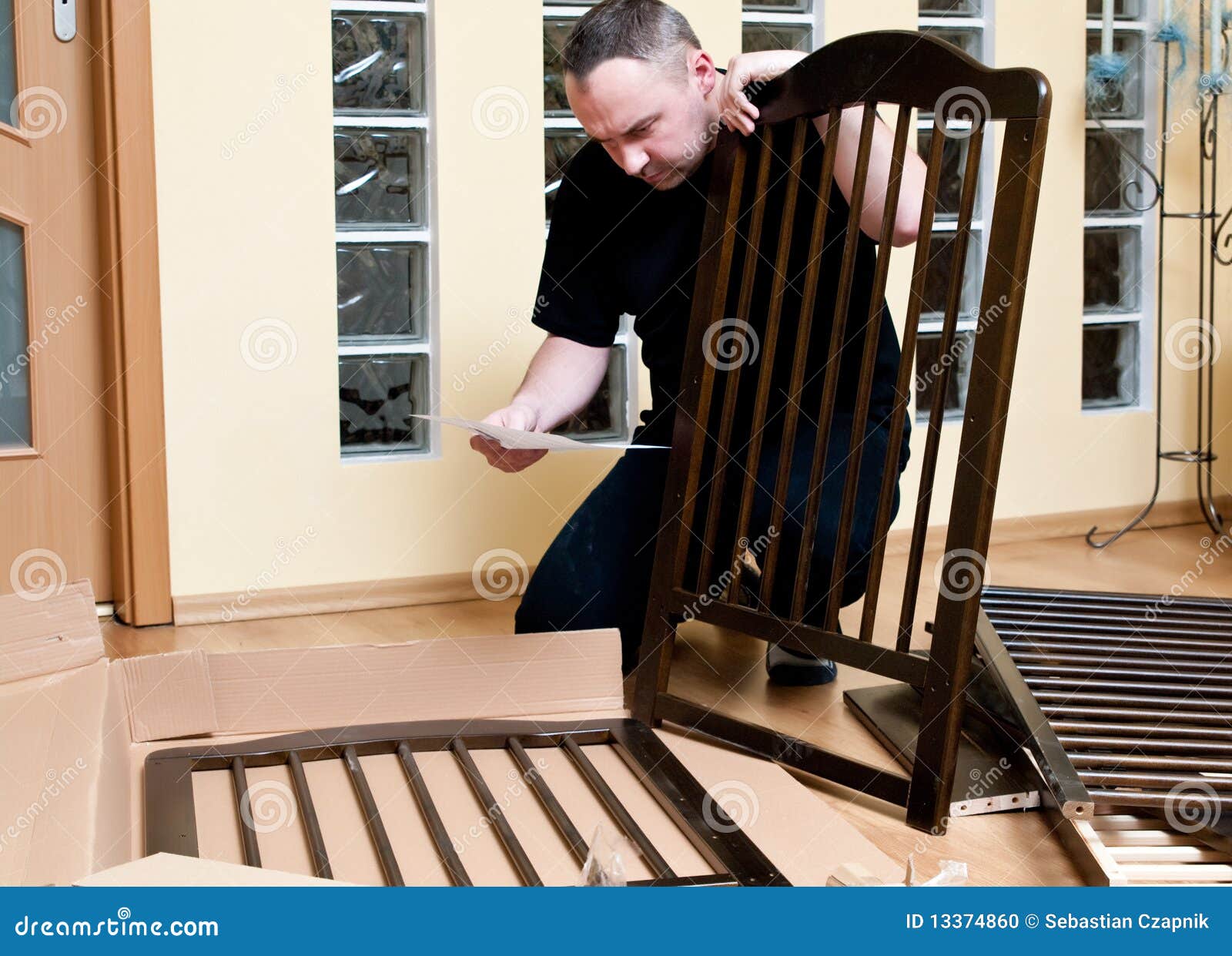 Man assembles a baby crib stock photo. Image of crib - 13374860