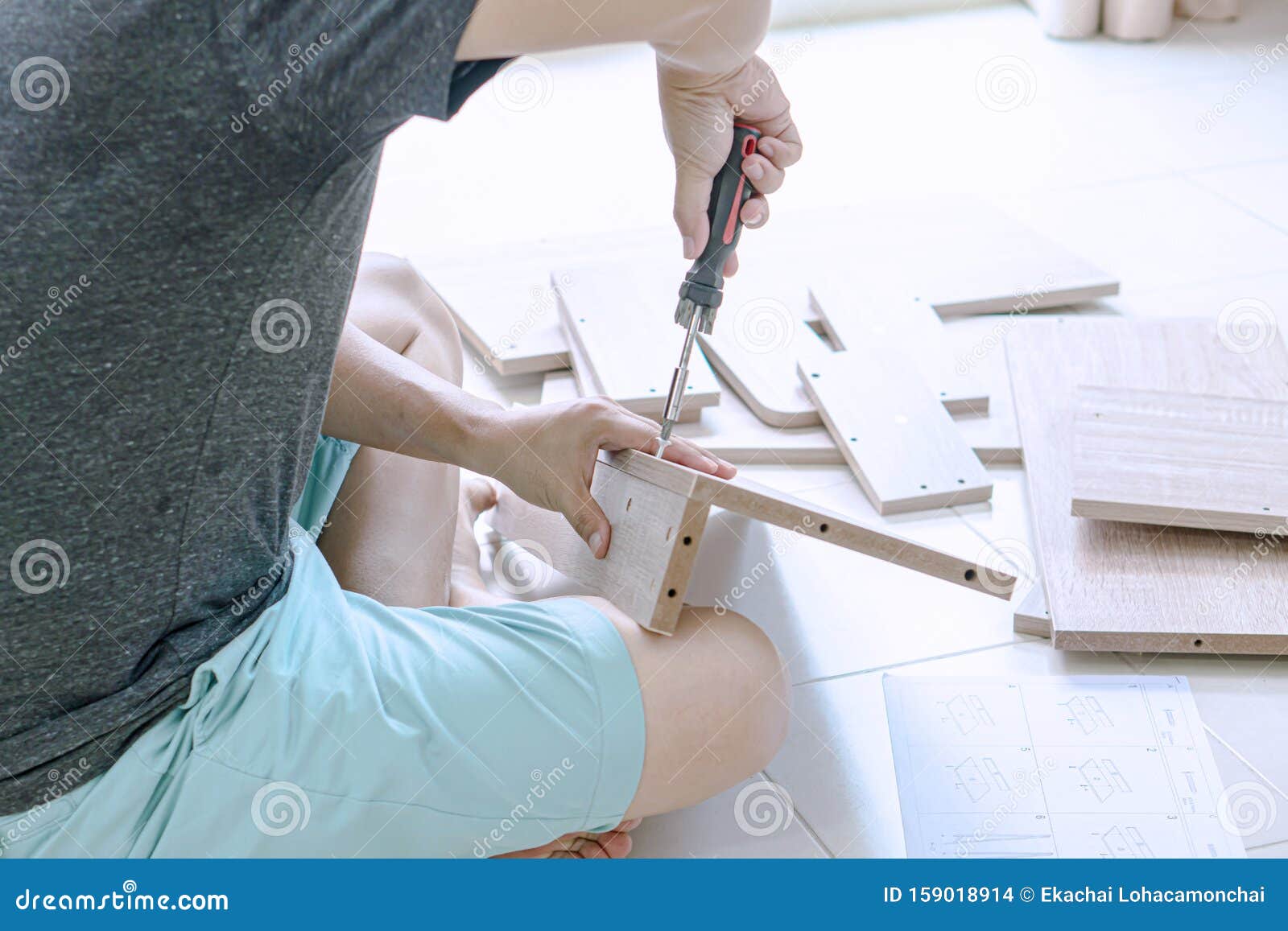 Man Assembling Furniture in His New Home Stock Photo - Image of ...