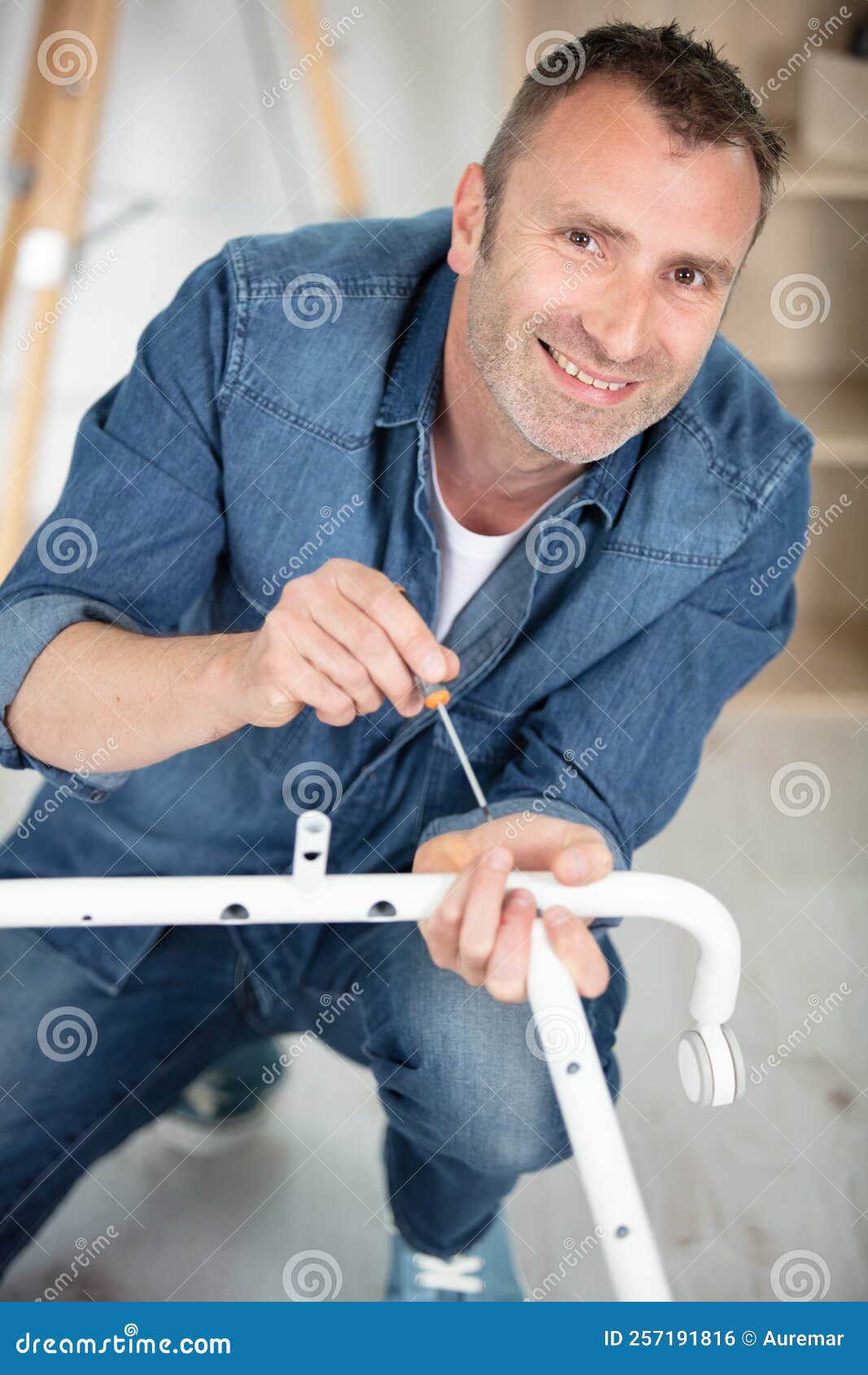 Man Assembling Metal Frame with Screwdriver Stock Photo - Image of ...