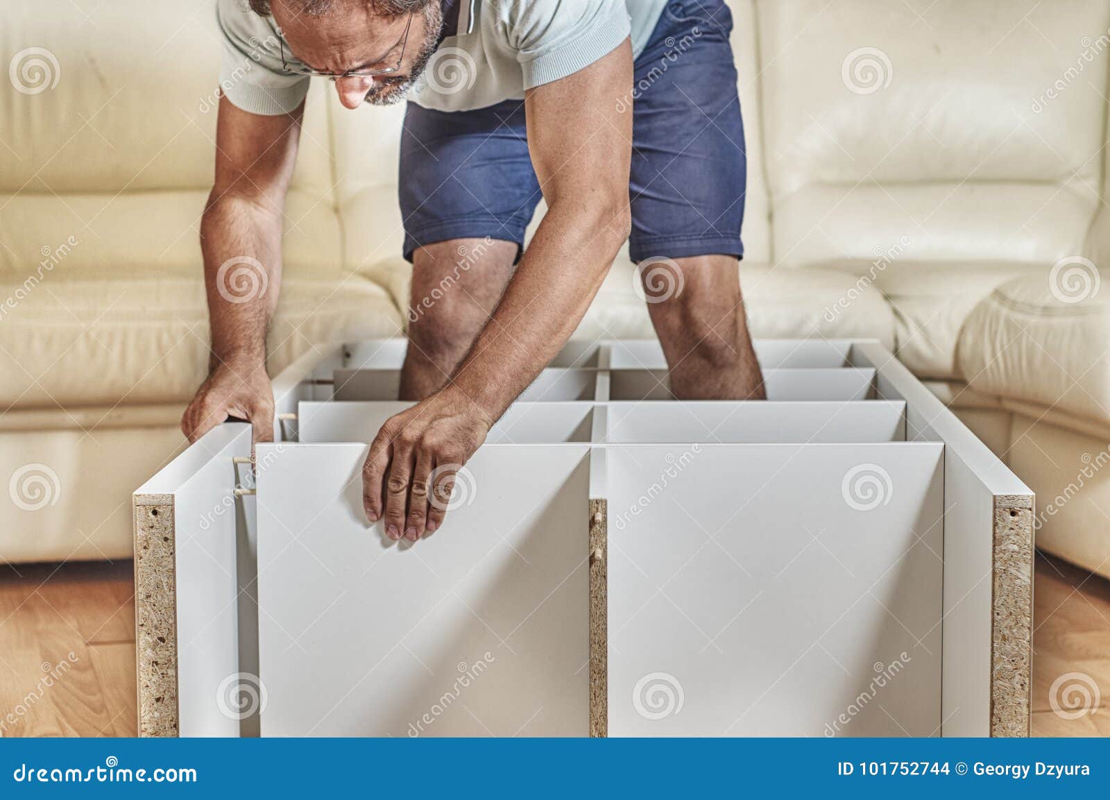 Man Assembling a Shelving at Home Stock Photo - Image of assembly ...