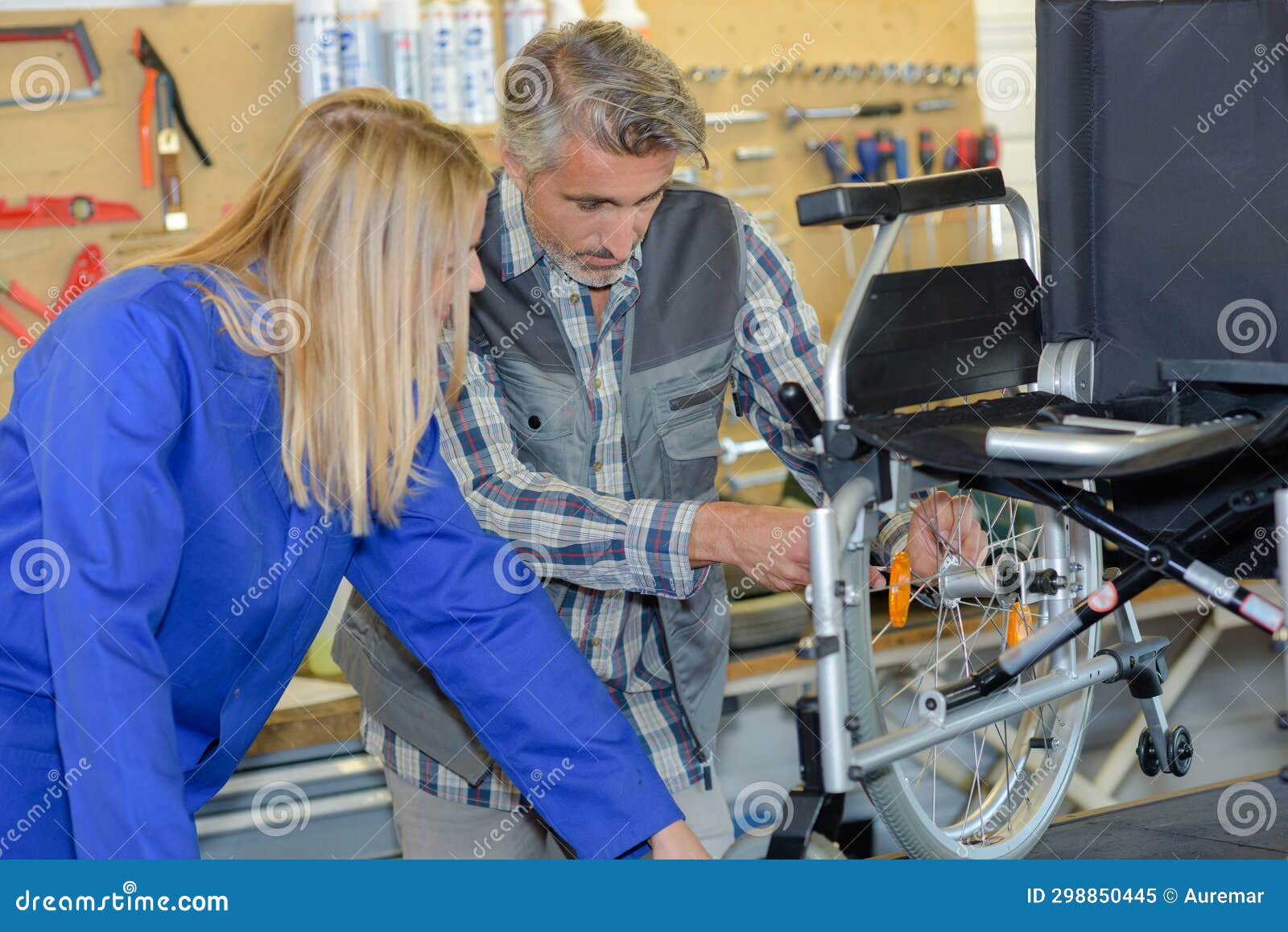 Man assembling wheelchair stock image. Image of disabled - 298850445