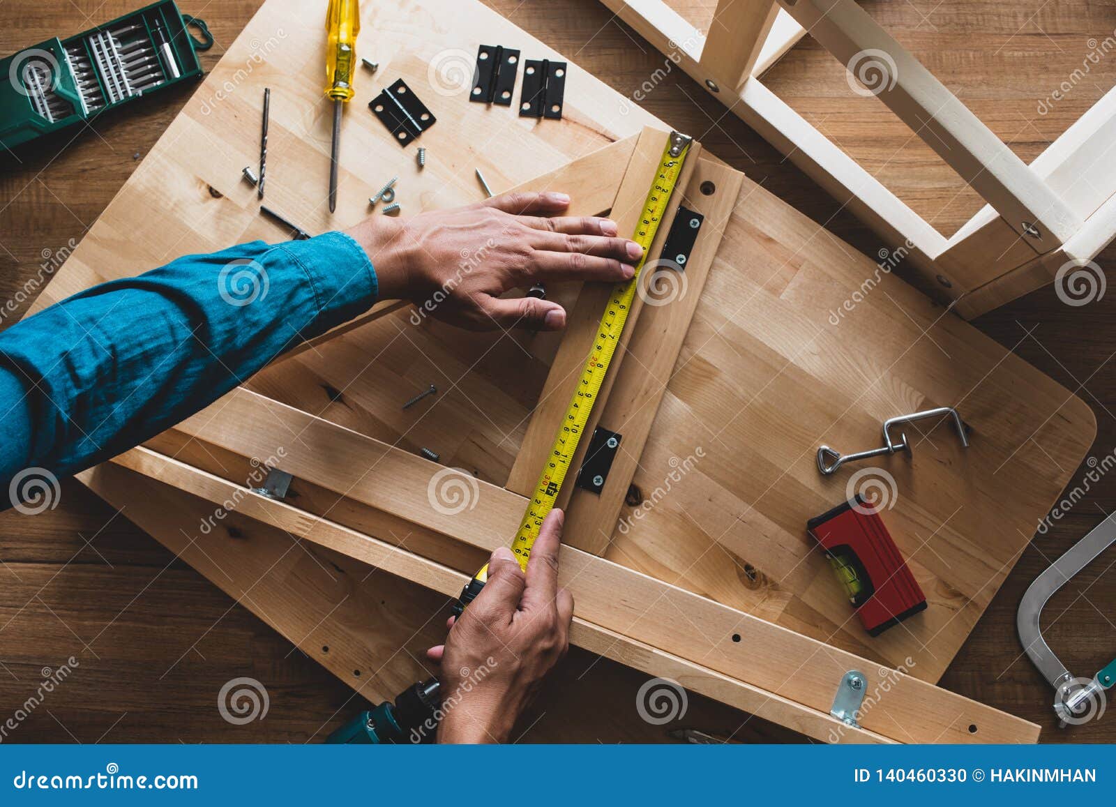 Man Assembly Wooden Furniture Fixing Or Repairing House With Yellow