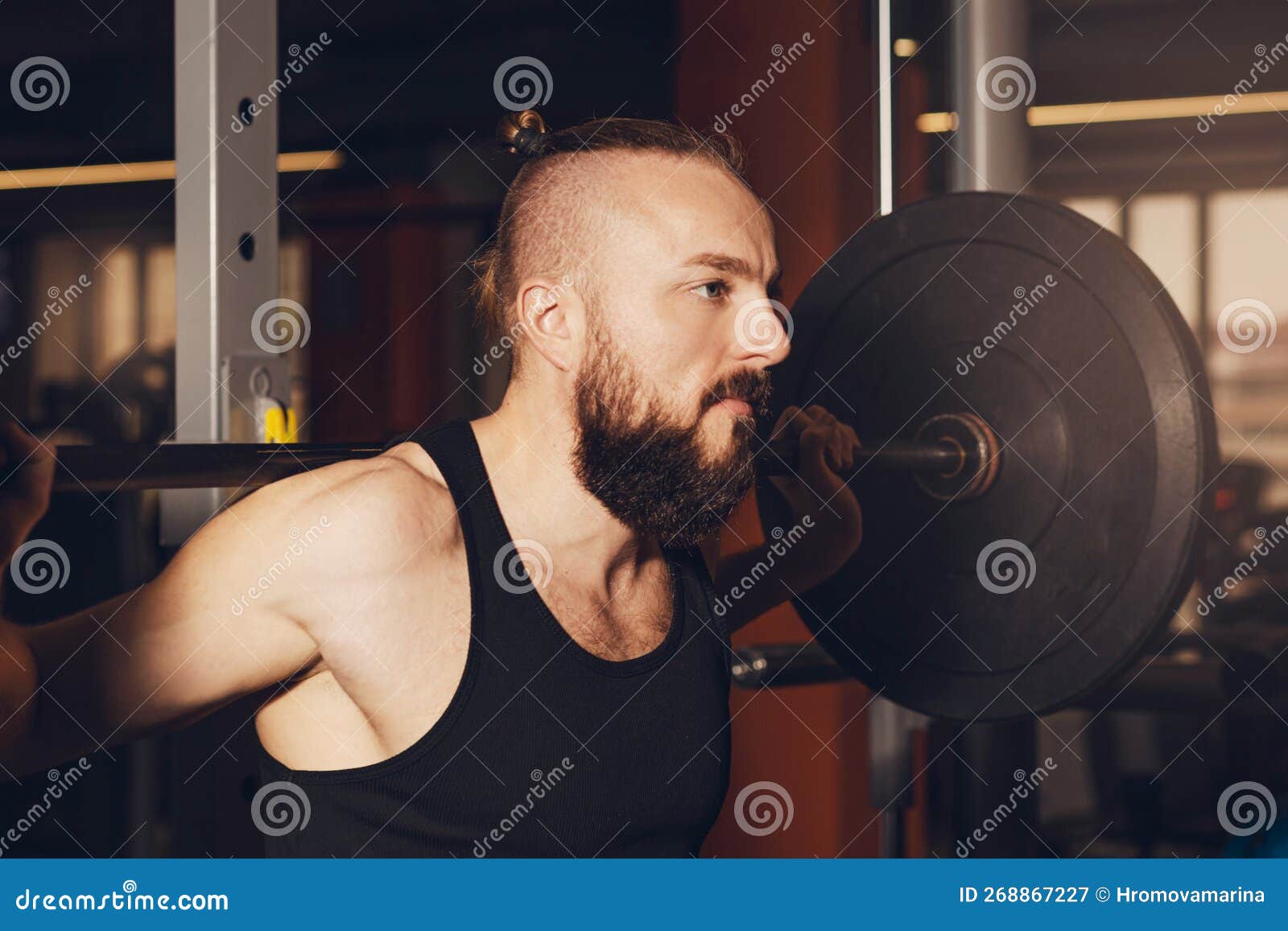 A Man of Athletic Build Does an Exercise with a Barbell Stock Image ...