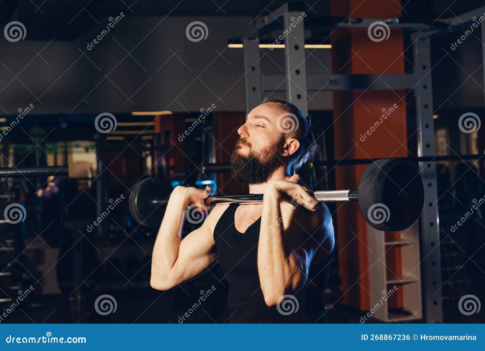A Man of Athletic Build Does an Exercise with a Barbell Stock Photo ...