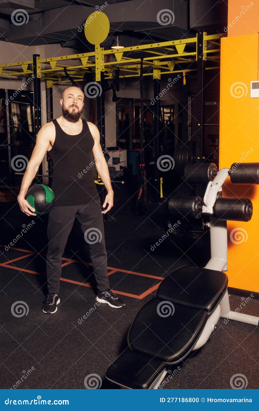 A Man of Athletic Build Poses Against the Background Stock Photo ...