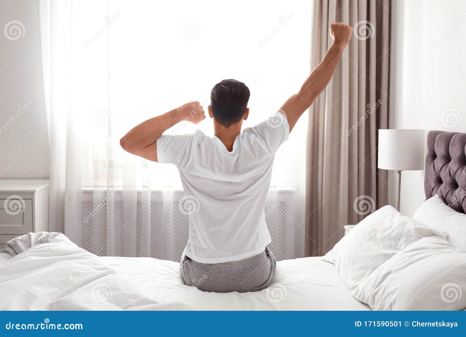 Man Awakening on Bed at Home Stock Image - Image of happy, pillow ...