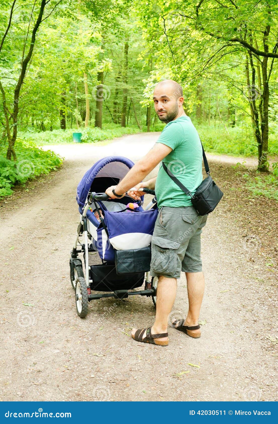 Man with baby buggy stock image. Image of path, father - 42030511