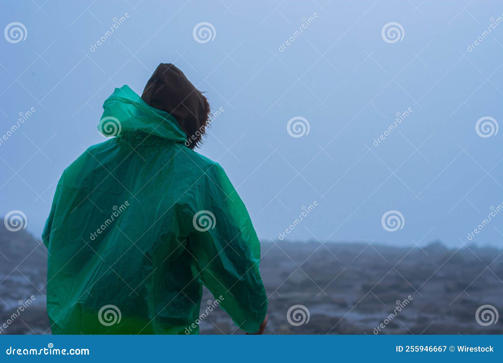 Man from the Back Wearing a Plastic Raining Suit and Looking from a ...