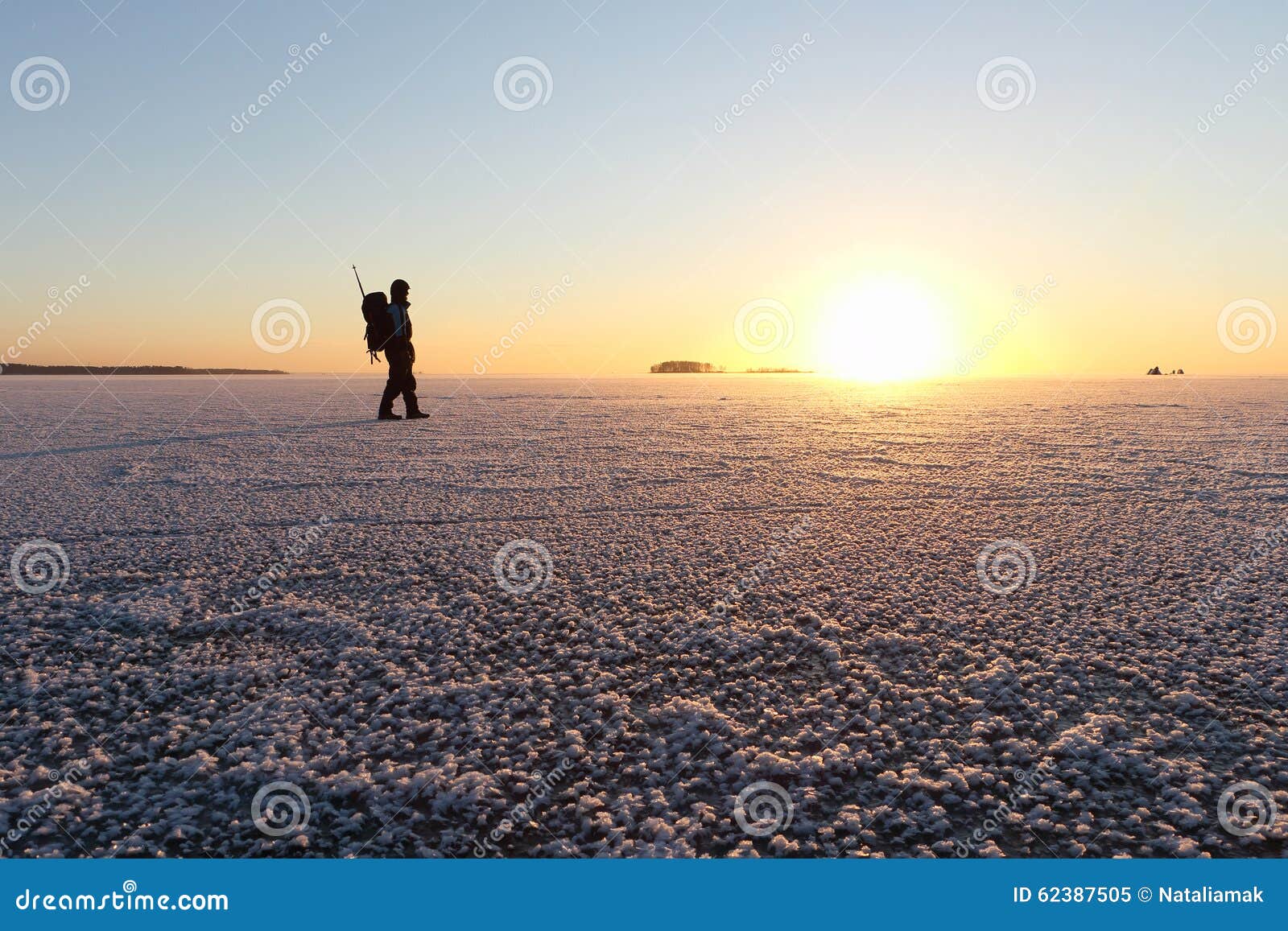 The Man with a Backpack Going on Ice on the River at Sunset Stock Image ...
