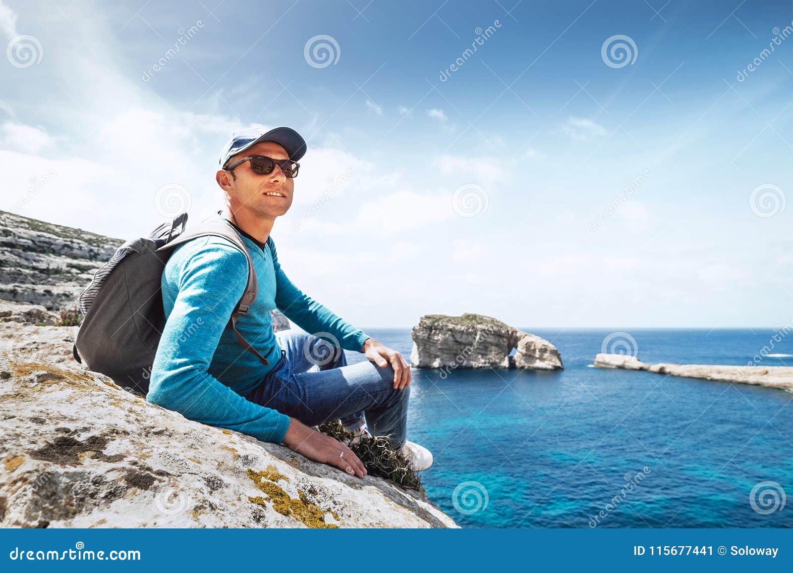 Man with Backpack Sits on the Rocky Seaside Stock Image - Image of ...