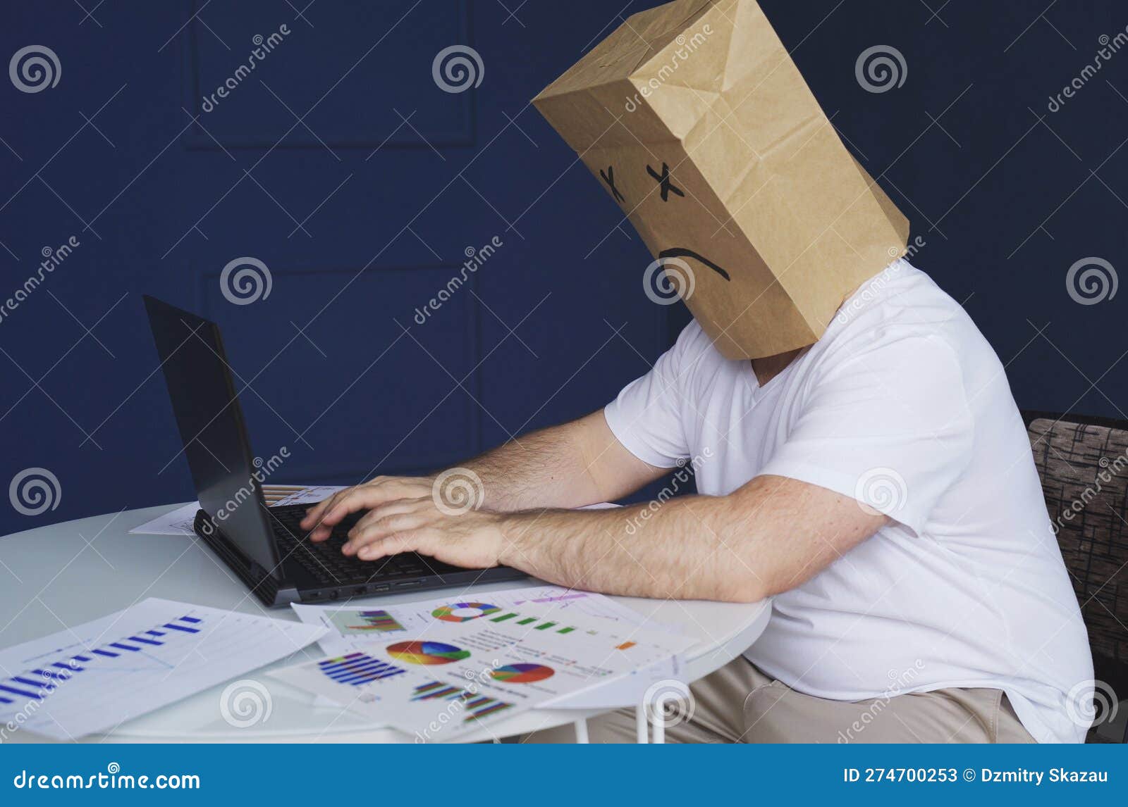 A Man with a Bag on His Head with a Drawn Sad Emoticon Works at a ...