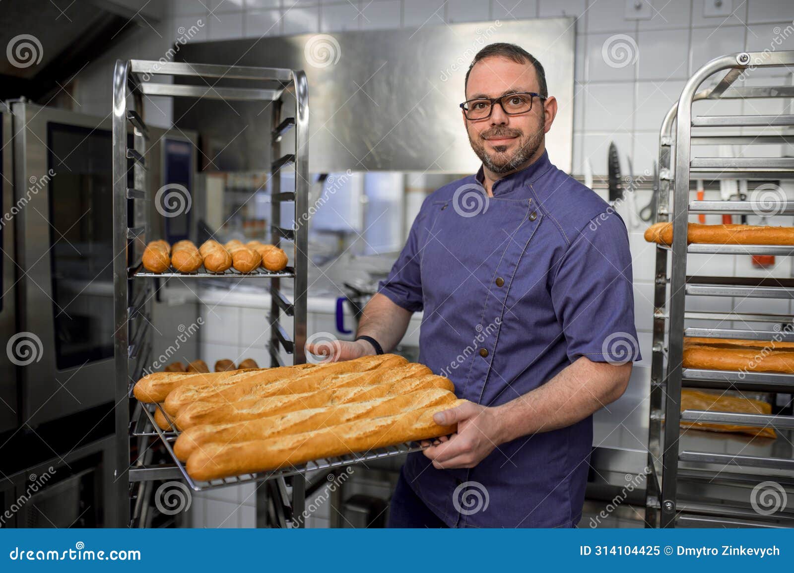 Man Baker Holding Baguettes on Tray in Bakehouse Kitchen Stock Image ...