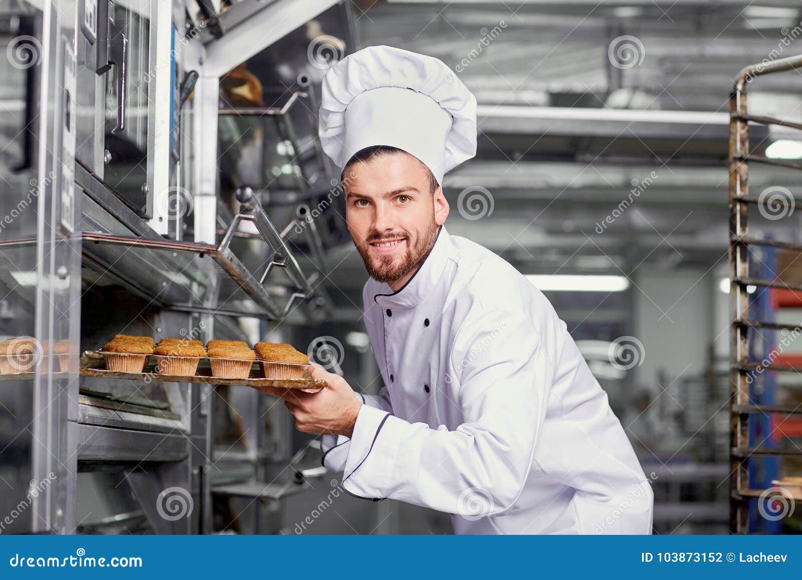 A Man Baker with a Tray of Cupcakes. Stock Photo - Image of male, cream ...
