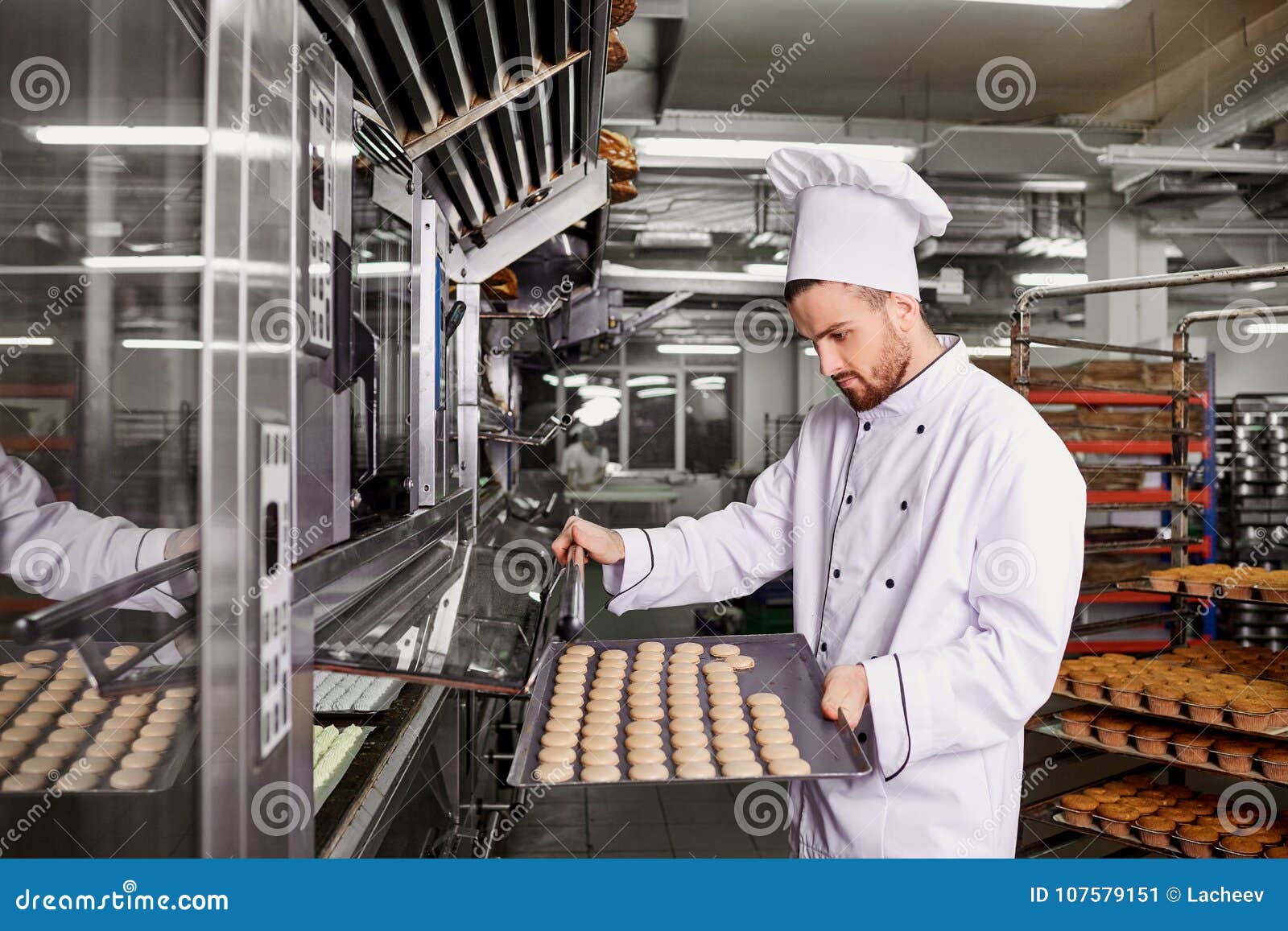 A Man Baker with a Tray of Cupcakes in a Bakery Stock Image - Image of ...