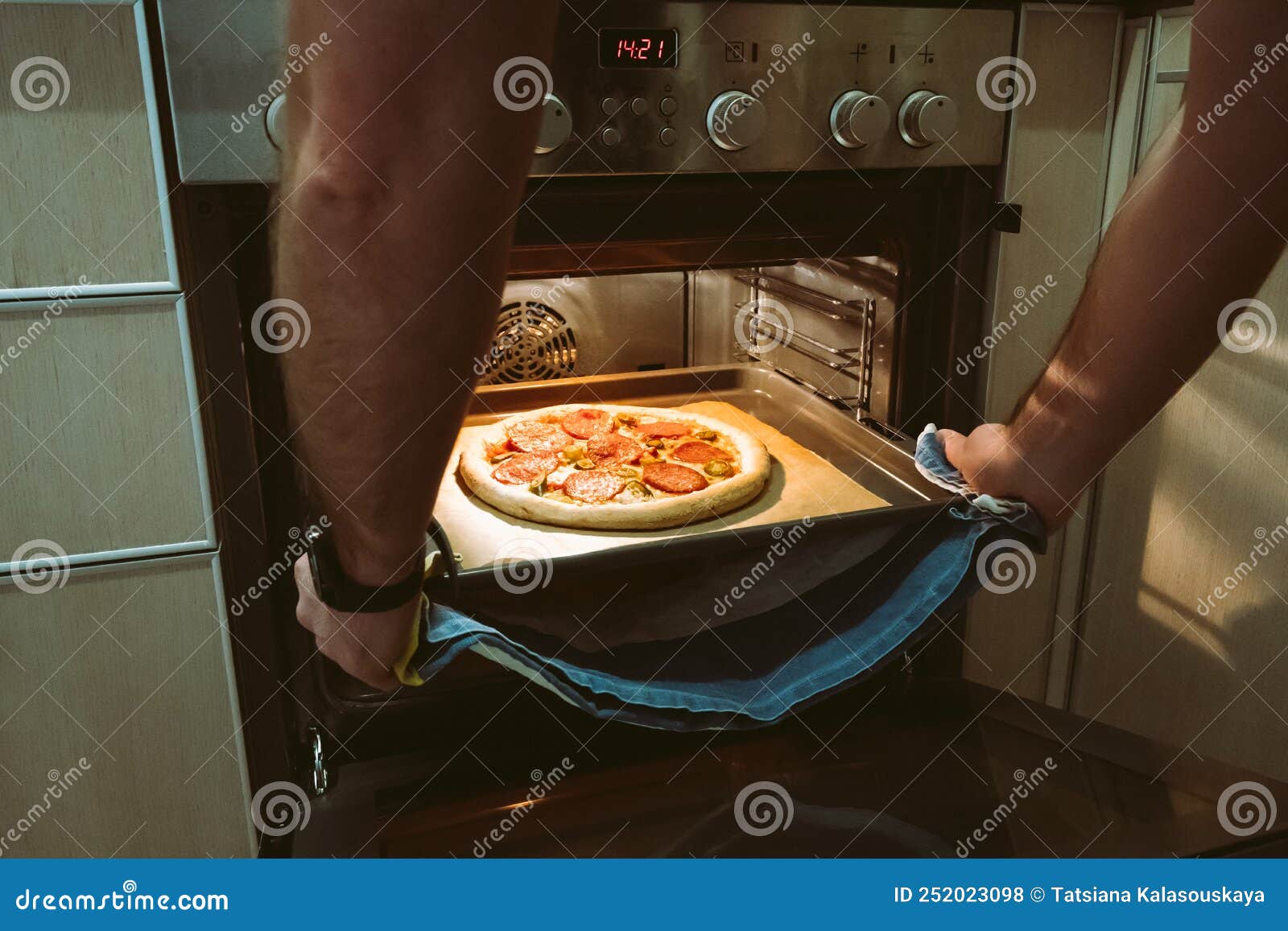 A Man Bakes Pizza At Home Using An Oven. Men& X27;s Hands Pull A Pizza ...