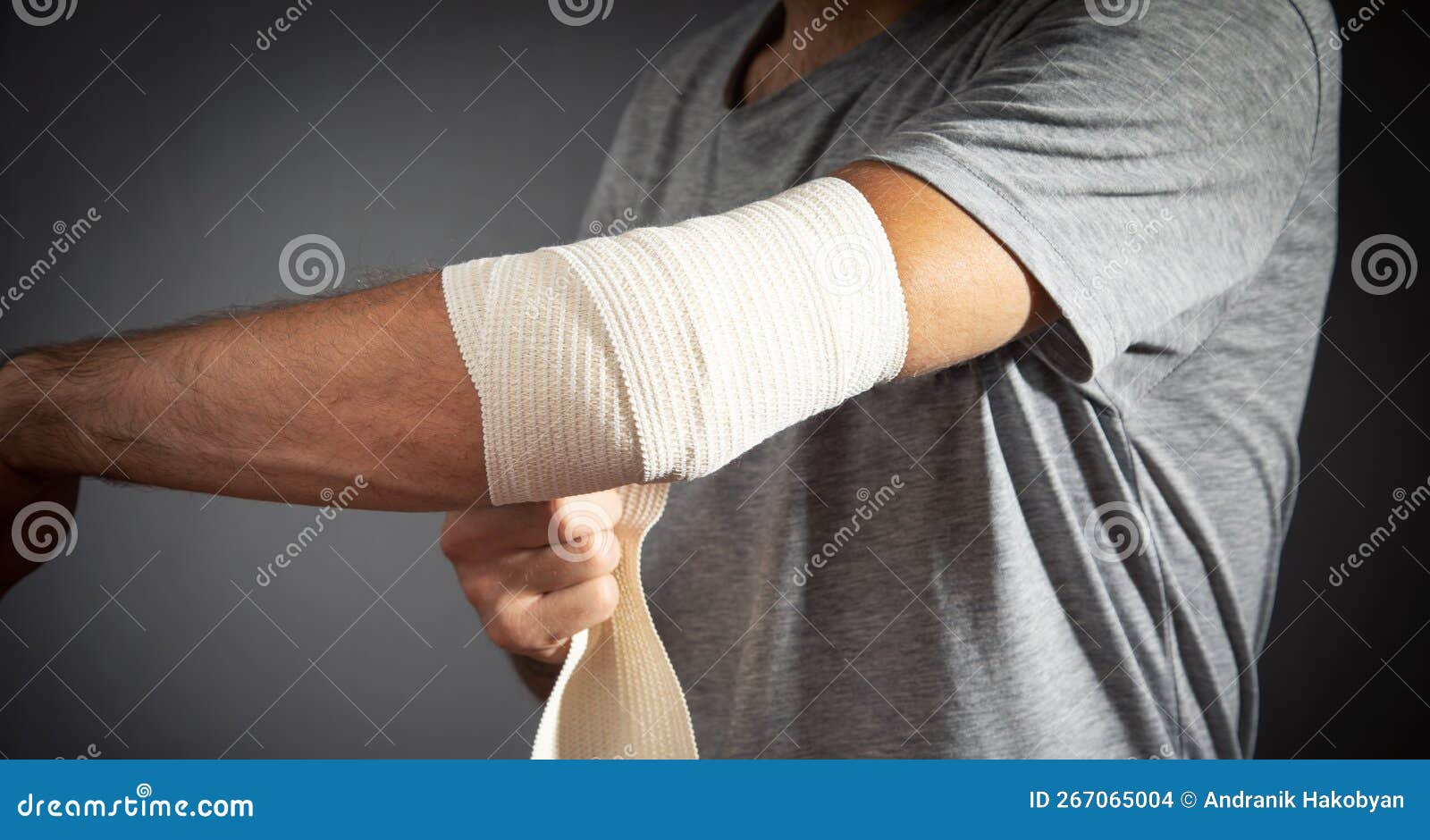 Man Bandaging an Elbow. First Aid and Medicine Concept Stock Photo ...
