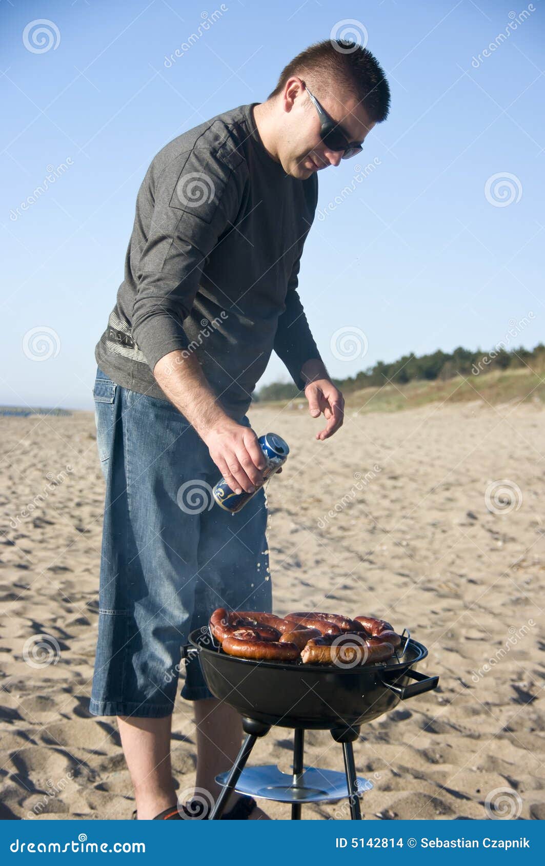 Man and barbecue on beach stock photo. Image of preparation - 5142814