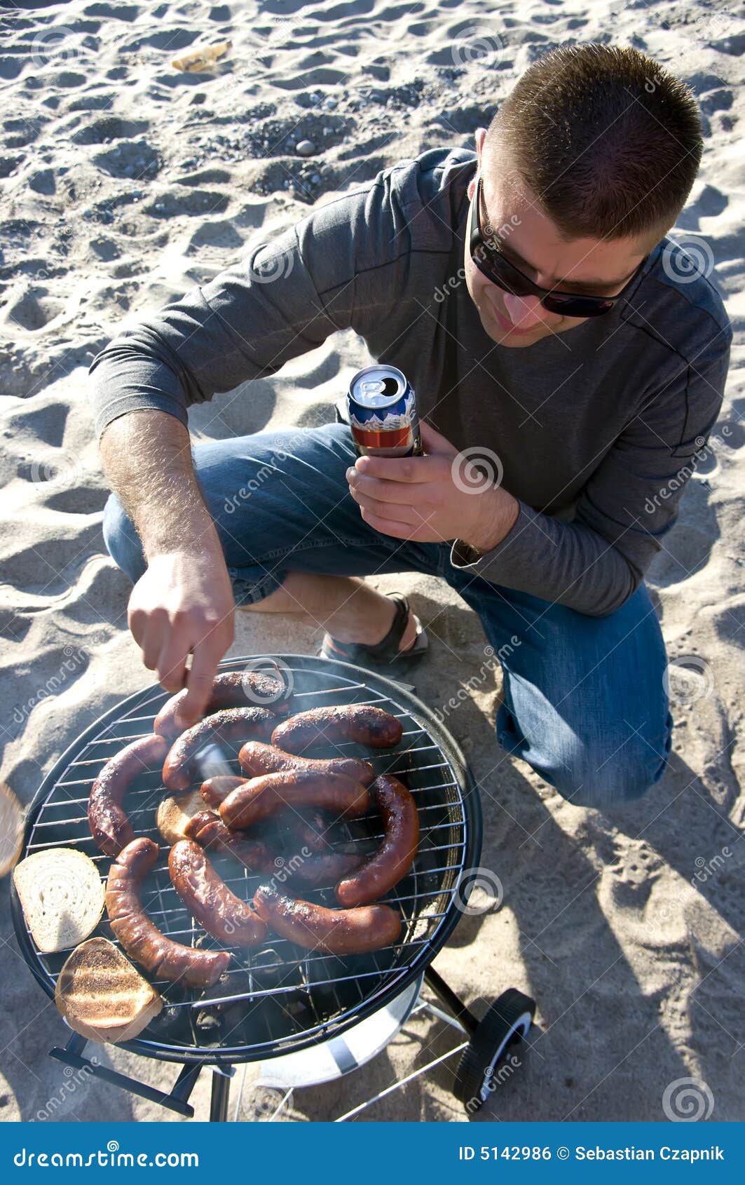 Man and barbecue on beach stock photo. Image of beer, fire - 5142986