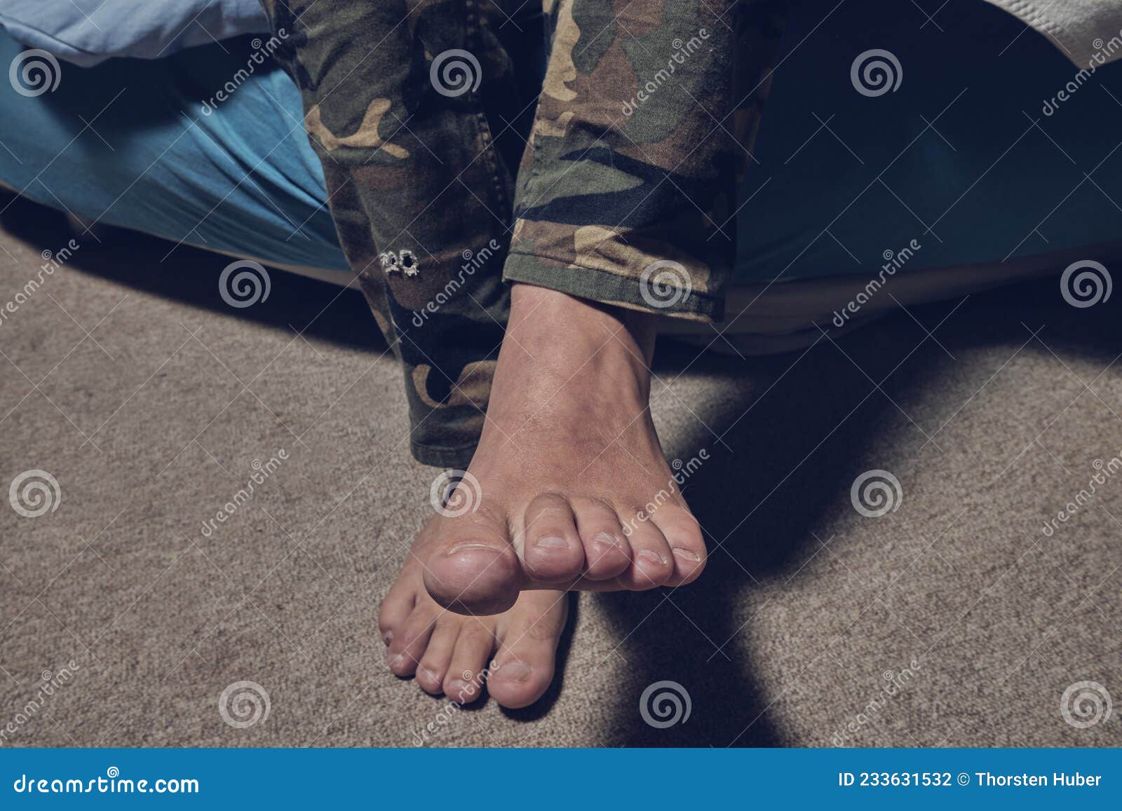 Man Barefoot Lifting One Foot Sitting on Bed Stock Photo - Image of ...