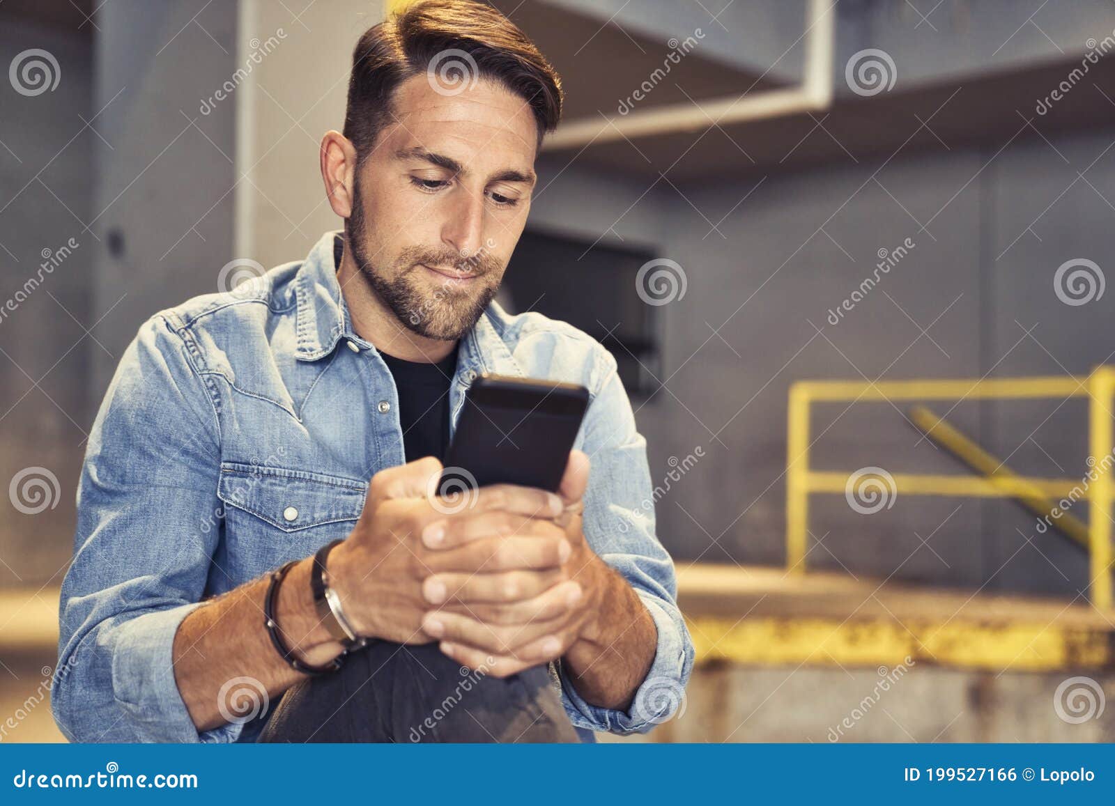Man on the Basement Background in the City Using Cellphone Stock Photo ...