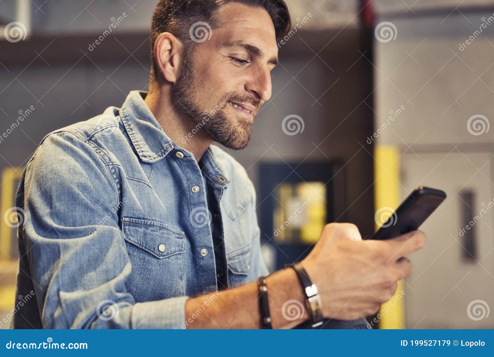 Man on the Basement Background in the City Using Cellphone Stock Image ...
