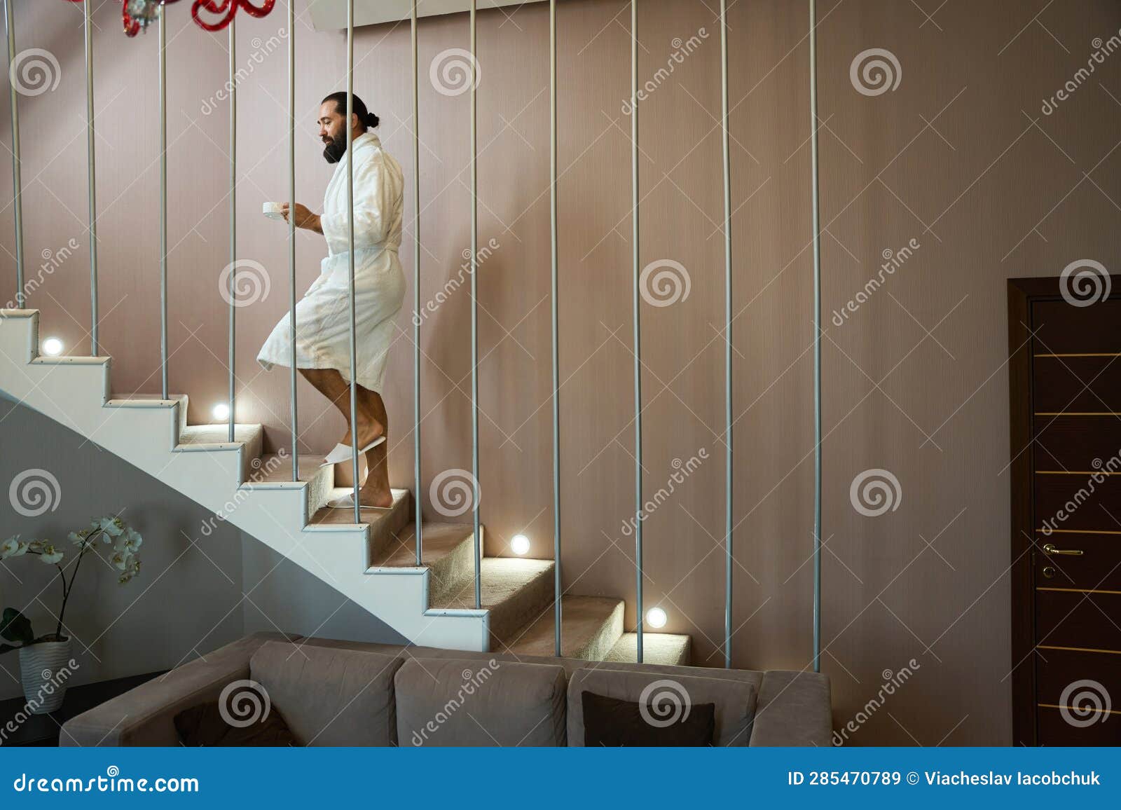 Man in Bathrobe Climbs the Stairs with Cup of Coffee Stock Image ...