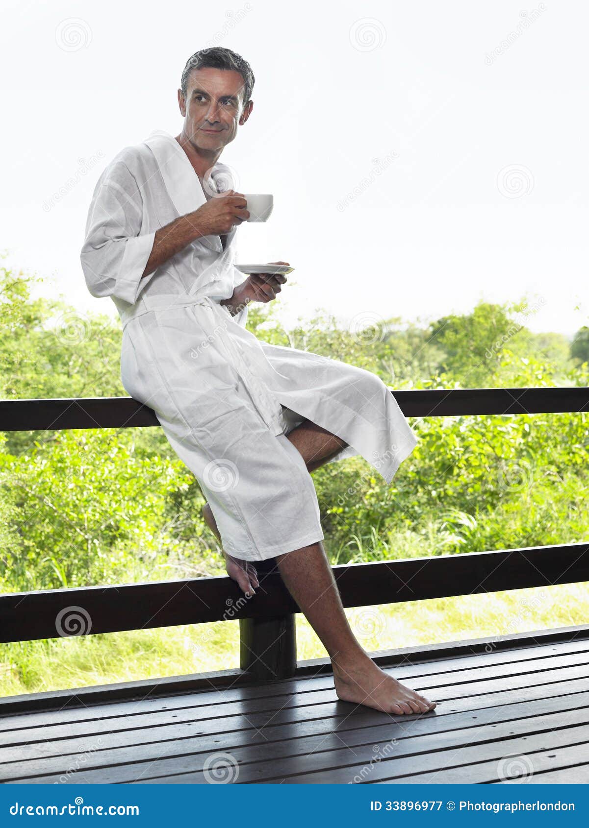 Man in Bathrobe on Terrace Railing with Tea Stock Image - Image of park ...