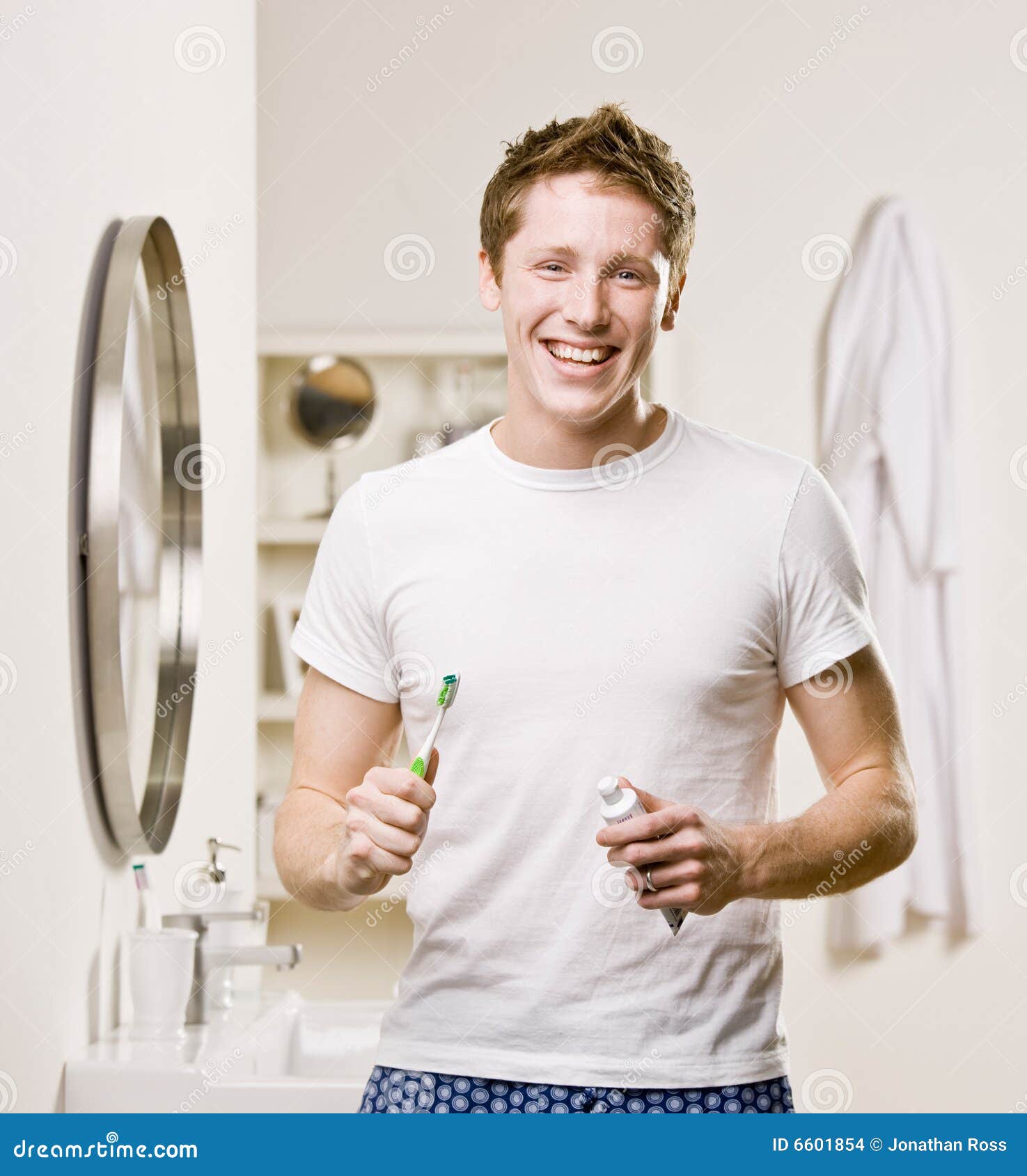 Man In Bathroom Holding Toothbrush And Toothpaste Stock Photo - Image ...