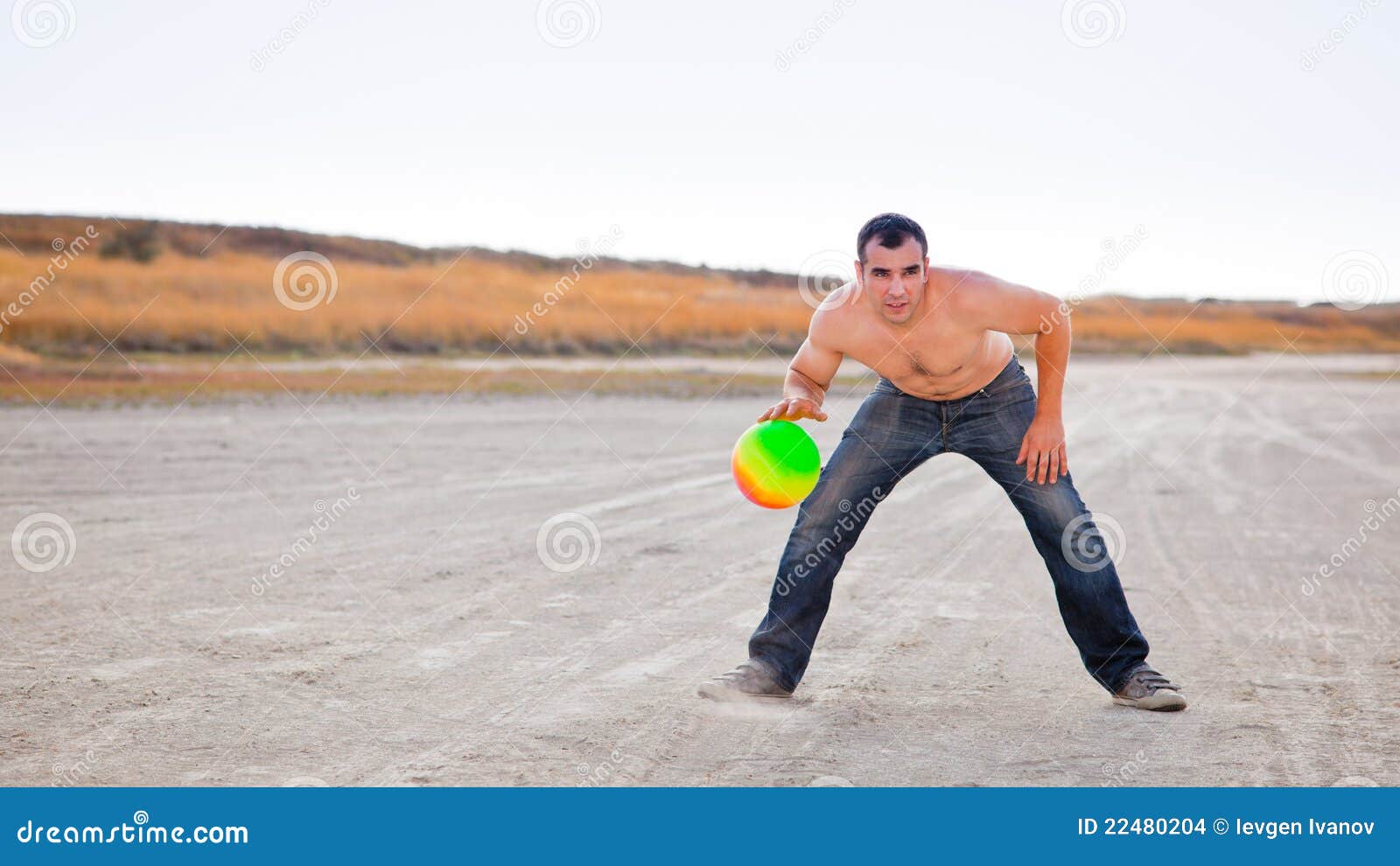 Man on beach with ball stock photo. Image of activity - 22480204