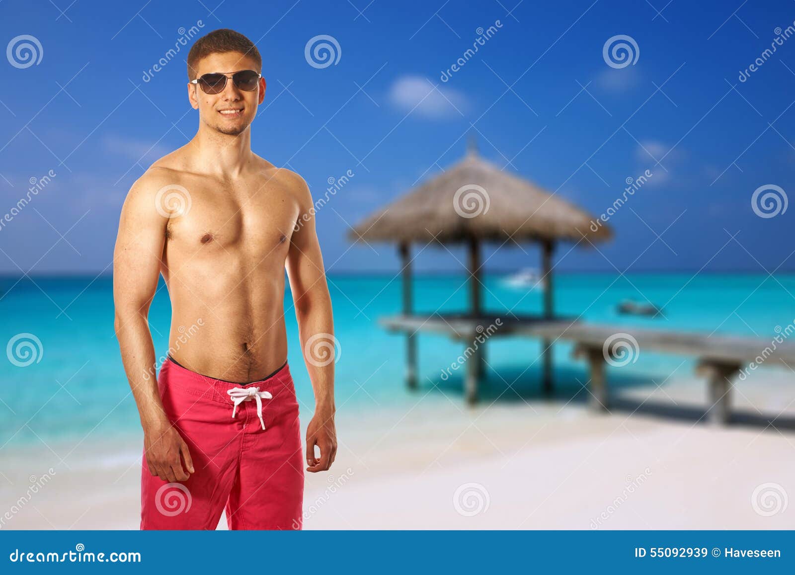 Man on beach with jetty stock image. Image of muscular - 55092939