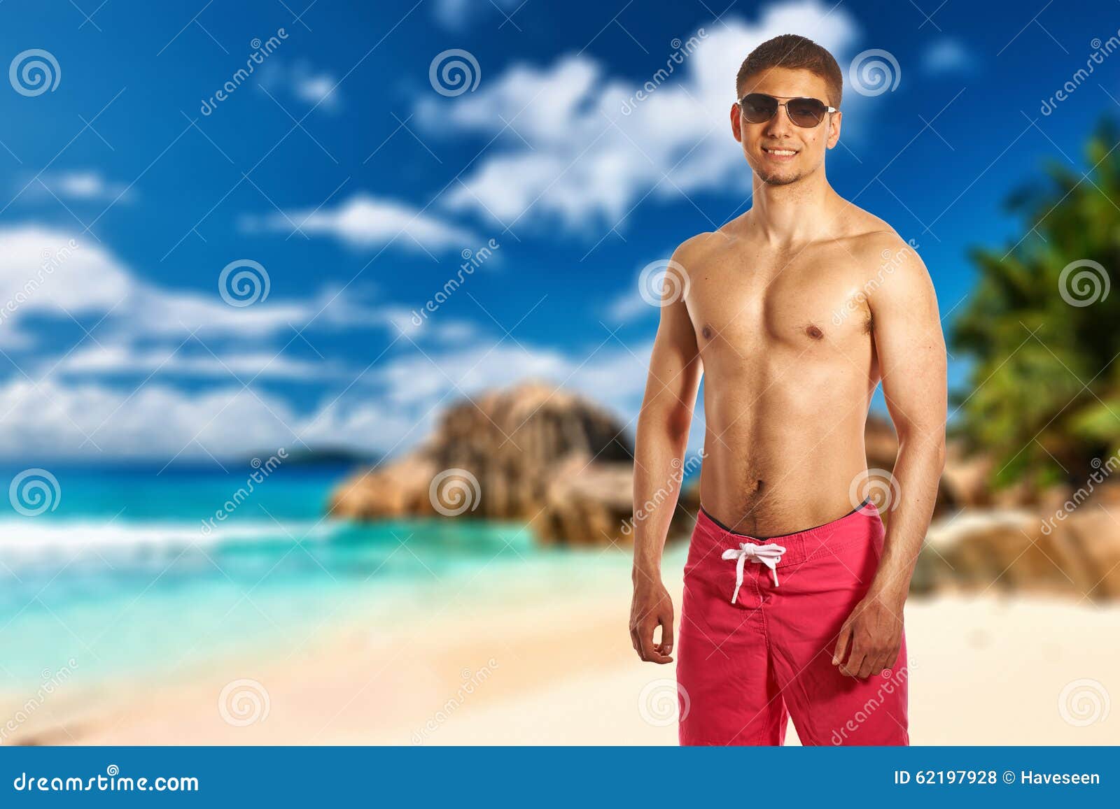 Man on beach at Seychelles stock photo. Image of lush - 62197928