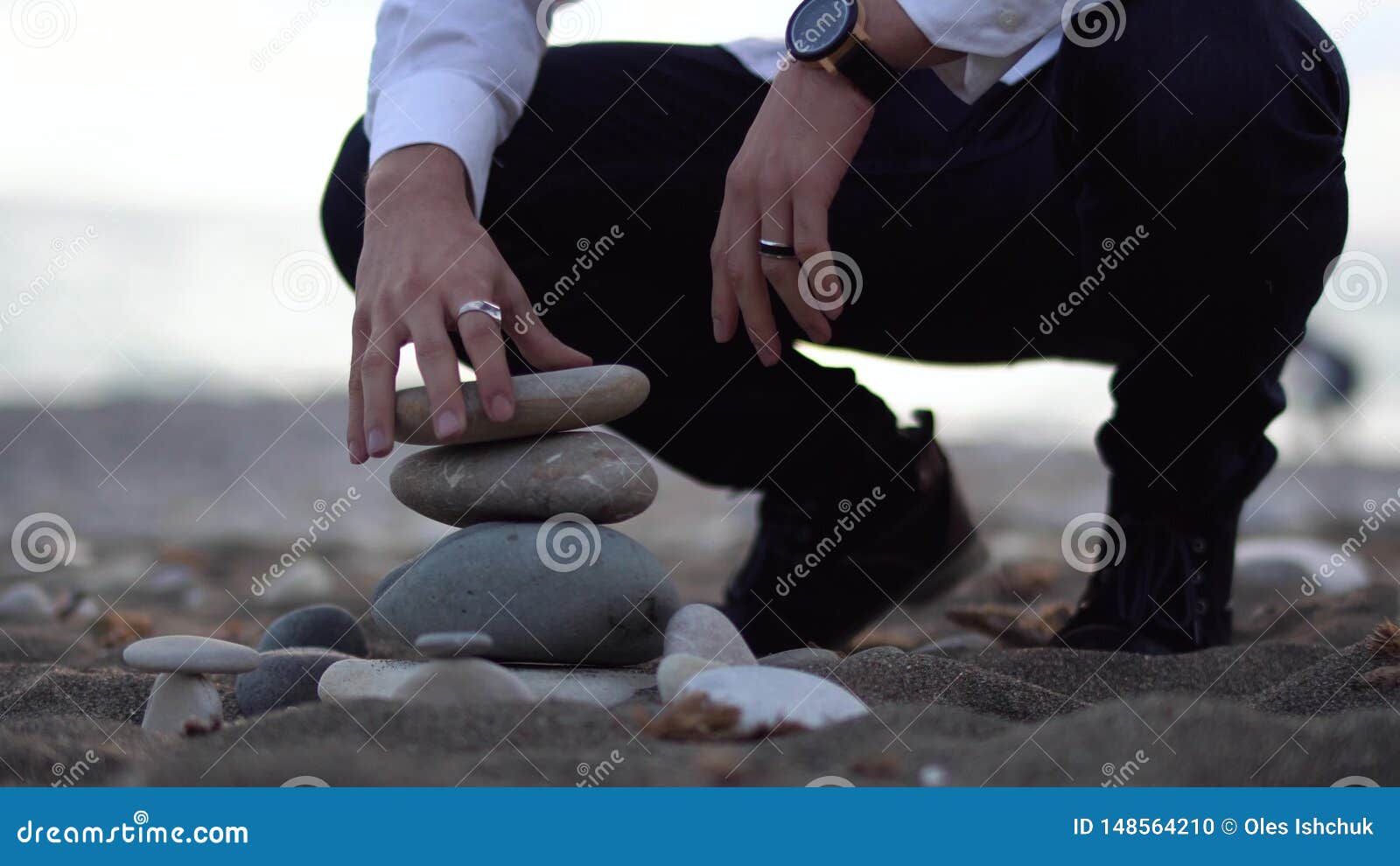 Man on the Beach Try To Build a Pyramid with Grey Stones but Its Not ...