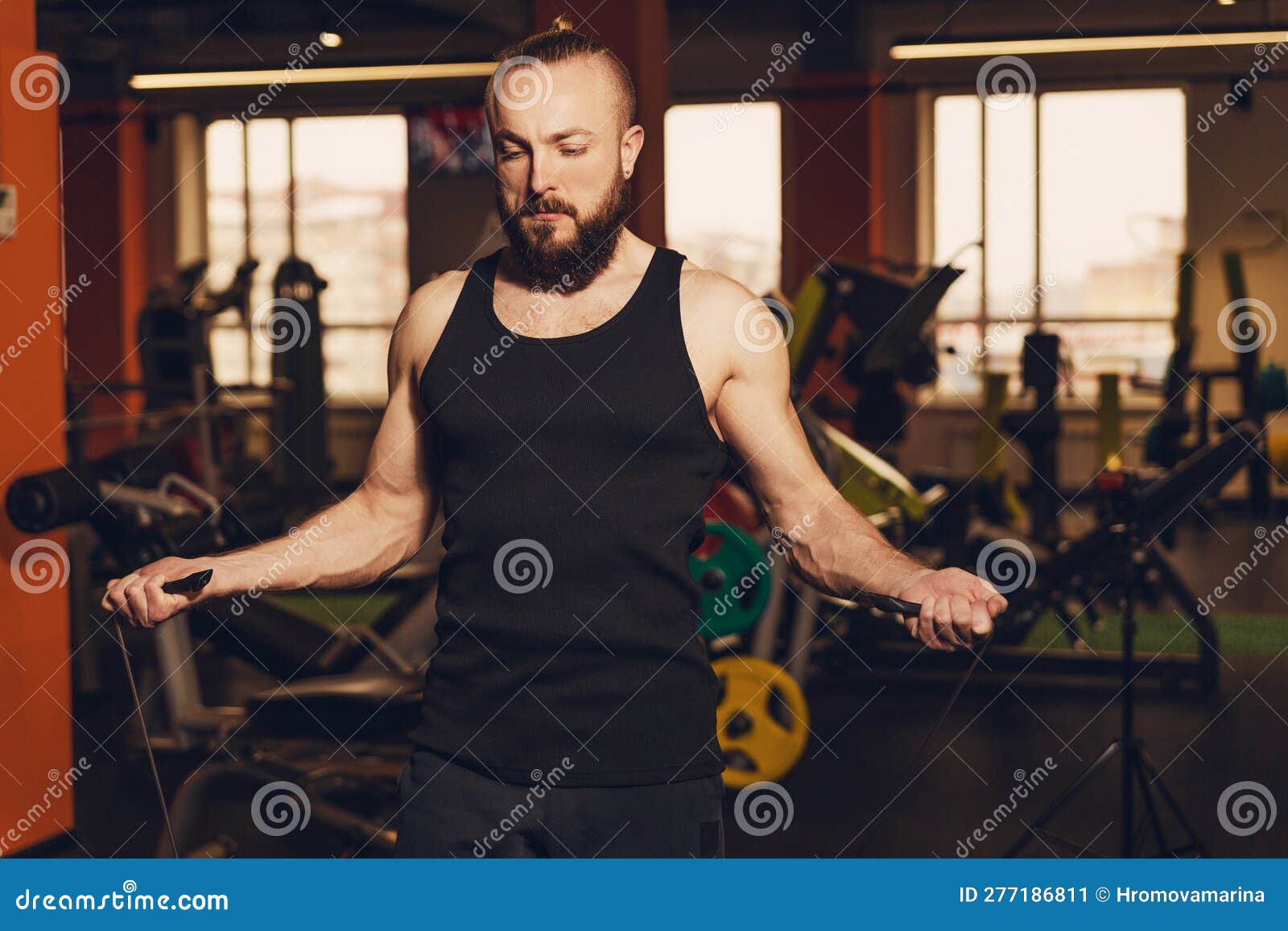A Man with a Beard of an Athletic Build Prepared To Jump and Do an ...