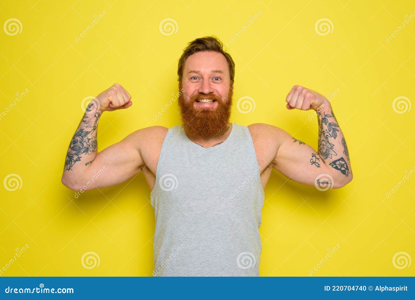Man with Beard and Tattoos Shows with Pride His Muscle Stock Photo ...