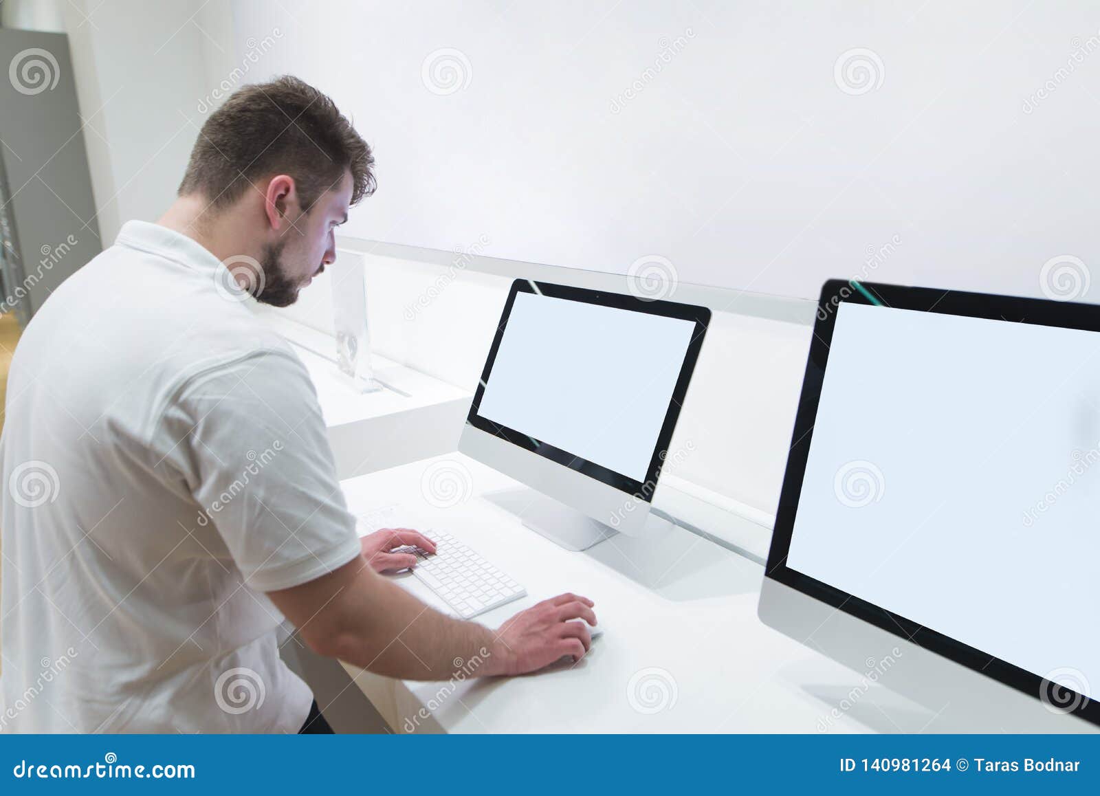 Man with a Beard Uses a Computer Monoblock with a White Screen in a ...