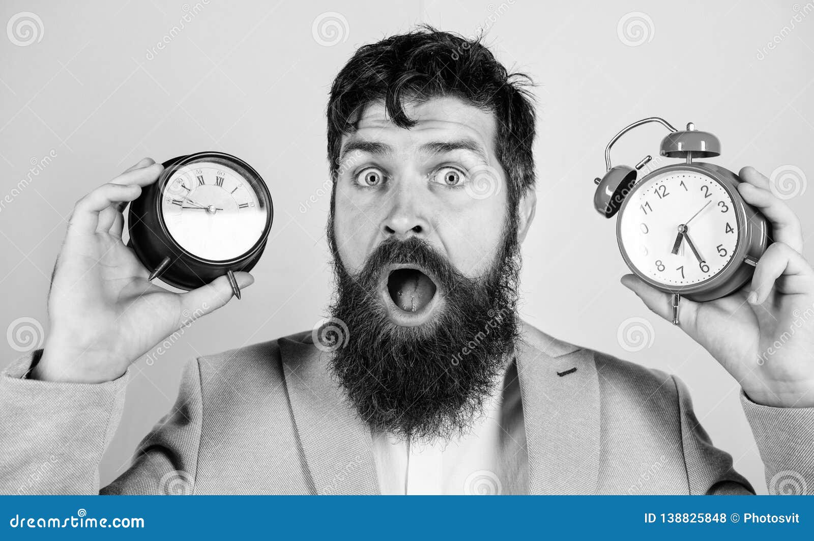 Man Bearded Hipster Hold Two Different Clocks. Guy Unshaven Puzzled ...