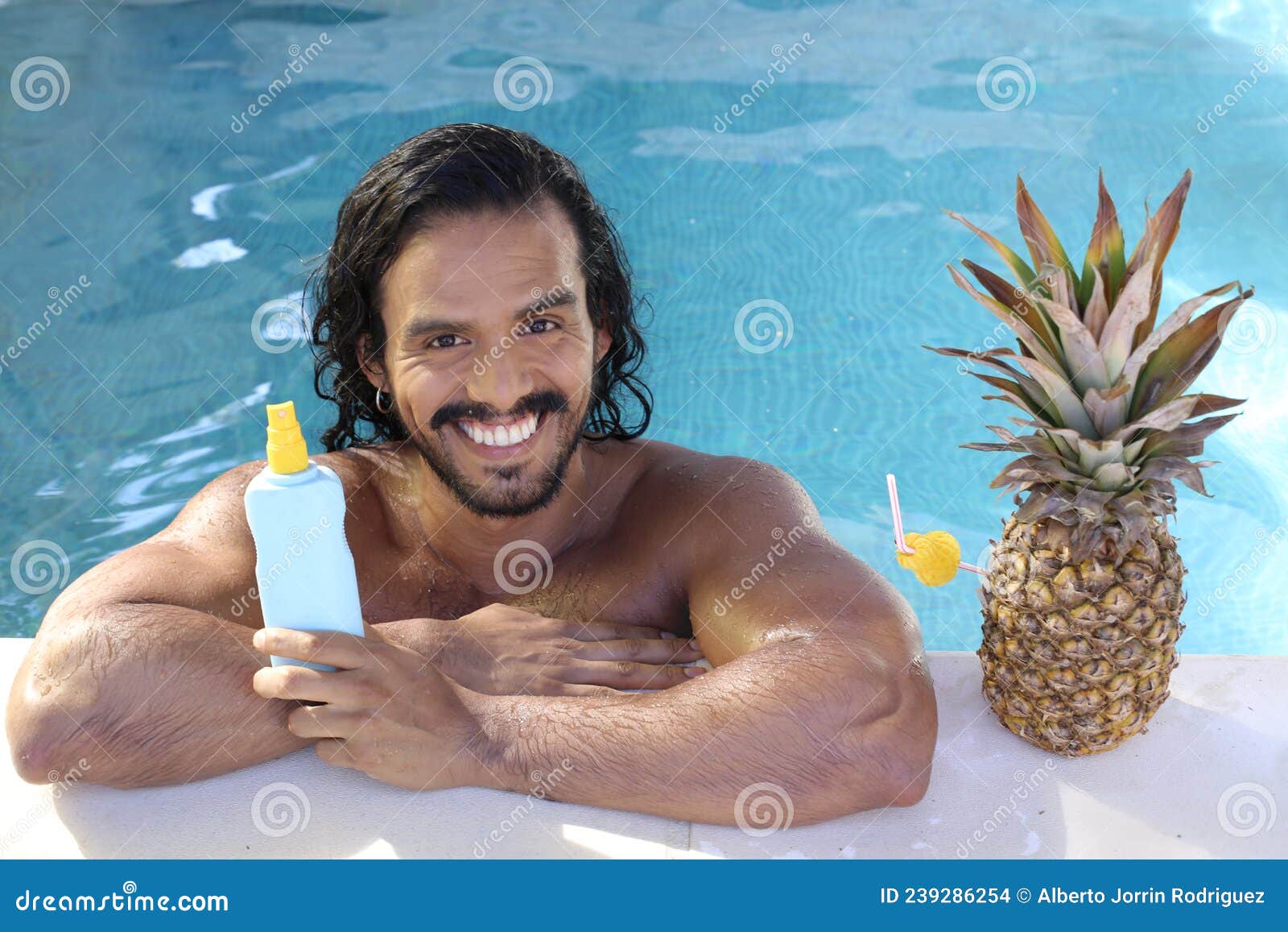 Man With Beautiful Olive Skin Using Sun Tan Lotion In Swimming Pool