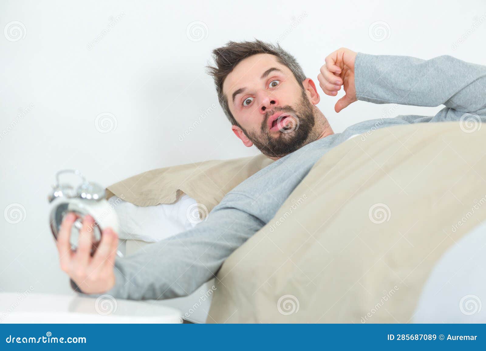 Man in Bed Looking in Shock at Time on Clock Stock Image - Image of ...