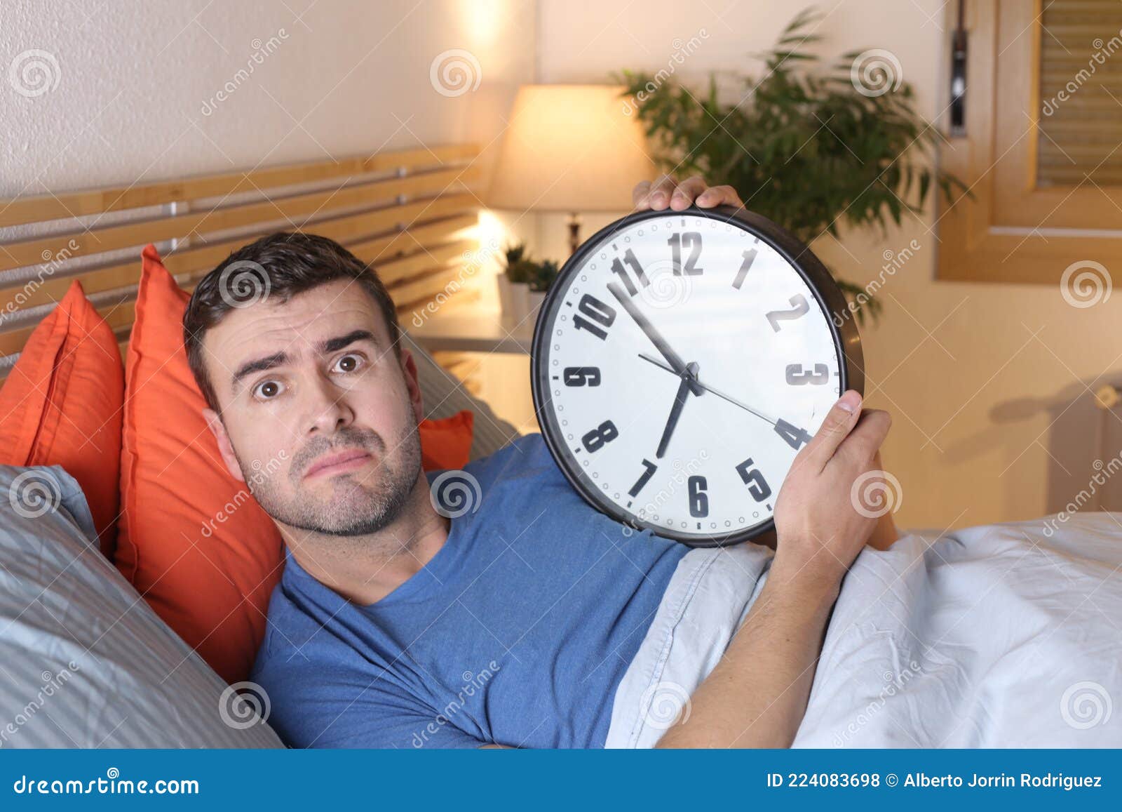 Man in Bed Thinking about Time Stock Photo - Image of clock, person ...