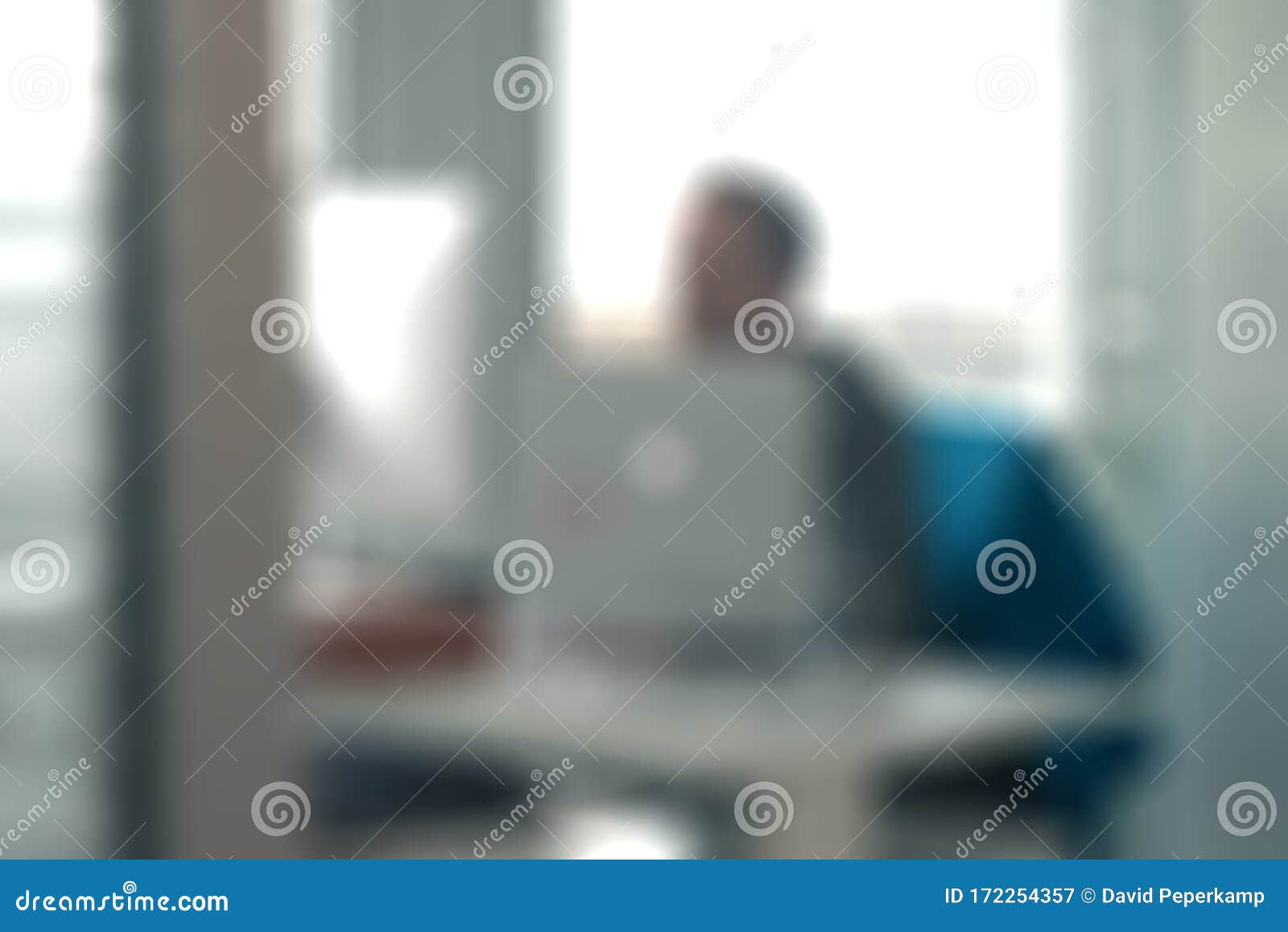 Man Behind a Computer at the Office, Blurred People at the Office ...